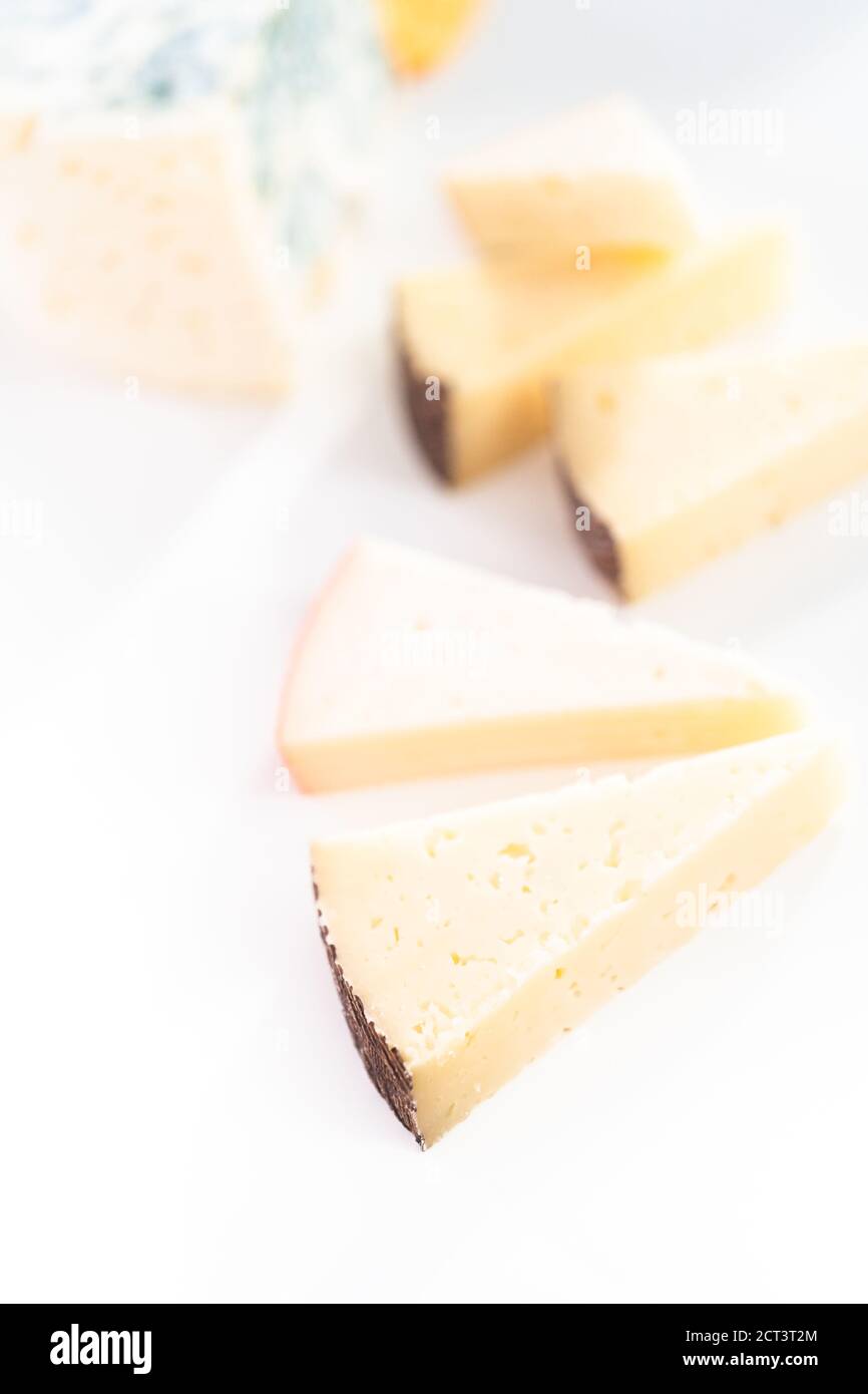Variety of large wedges gourmet cheese on a white background Stock ...