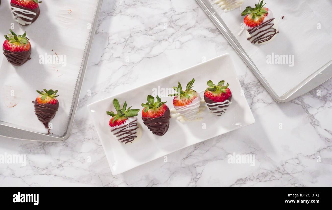 Flat lay. Step by step. Arranging chocolate strawberries on a white ...