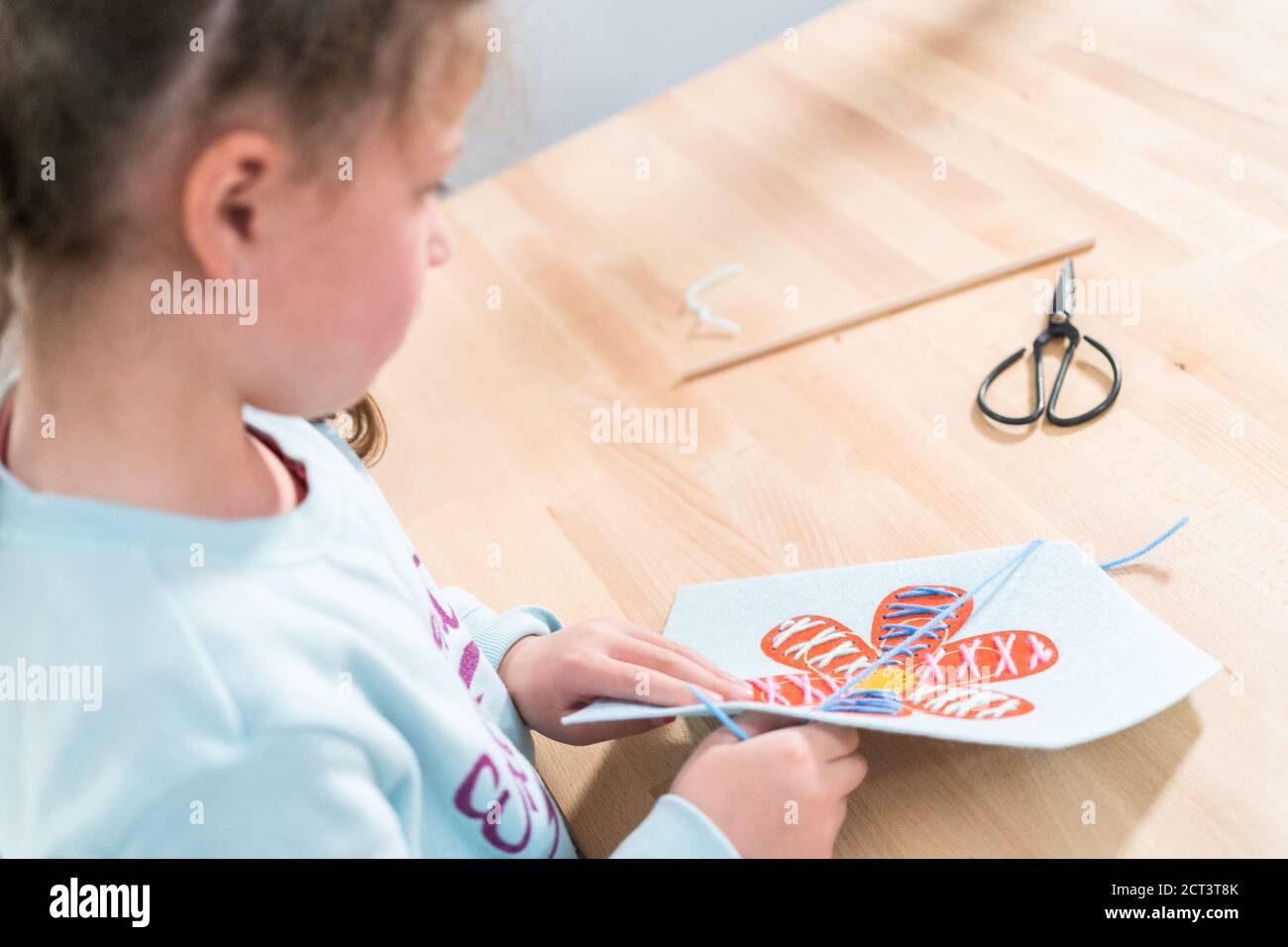Little girl learning how to sew with sewing craft kit for kids Stock ...