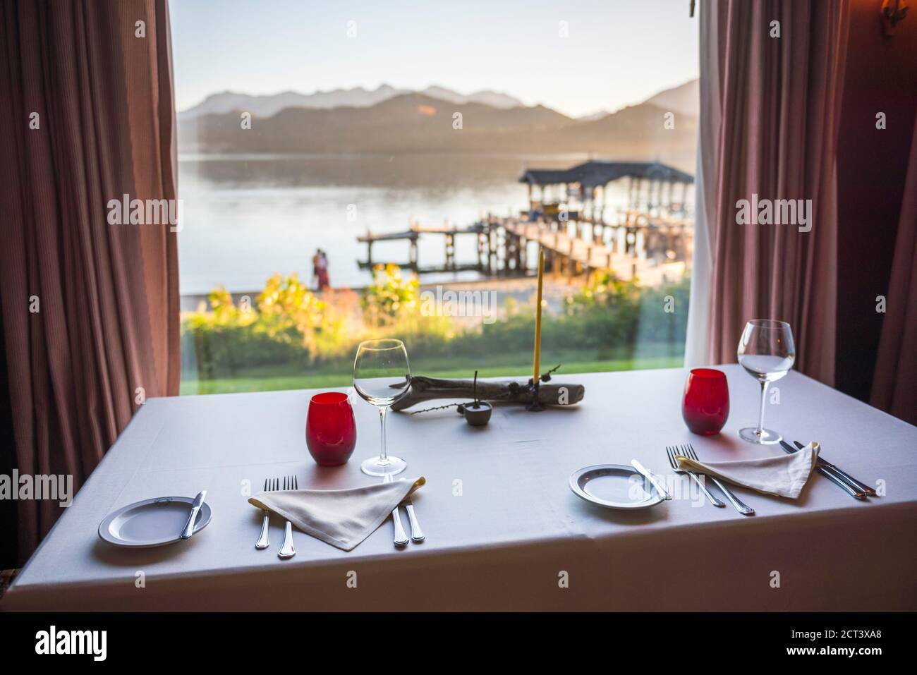 Table set up for dinner at a fine dining restaurant with wine glasses ...