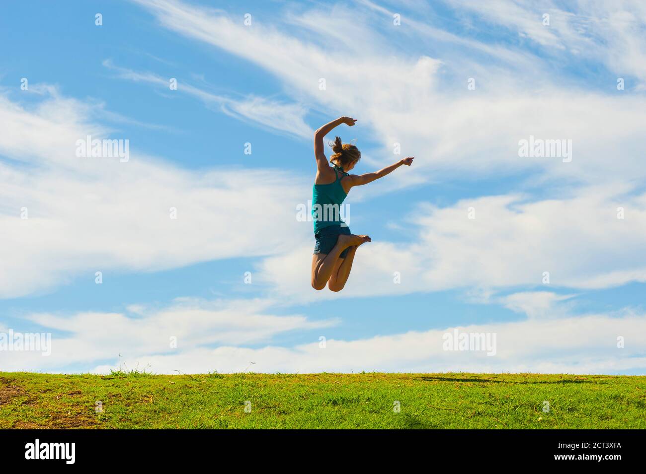 Happy woman jumping for joy, celebrating winning and enjoying happiness ...