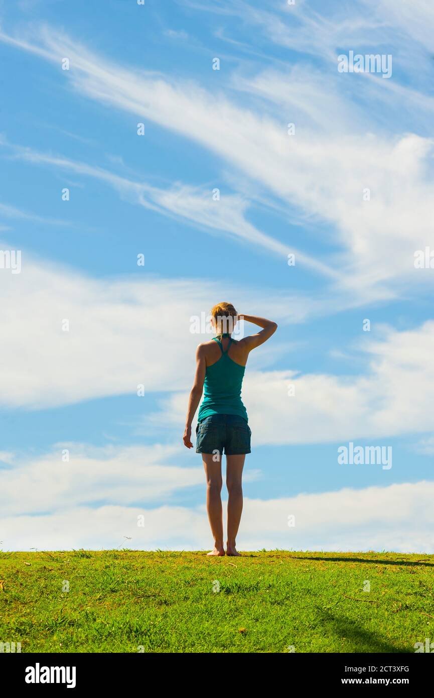 Woman standing, looking at a view with hope towards the future in a ...