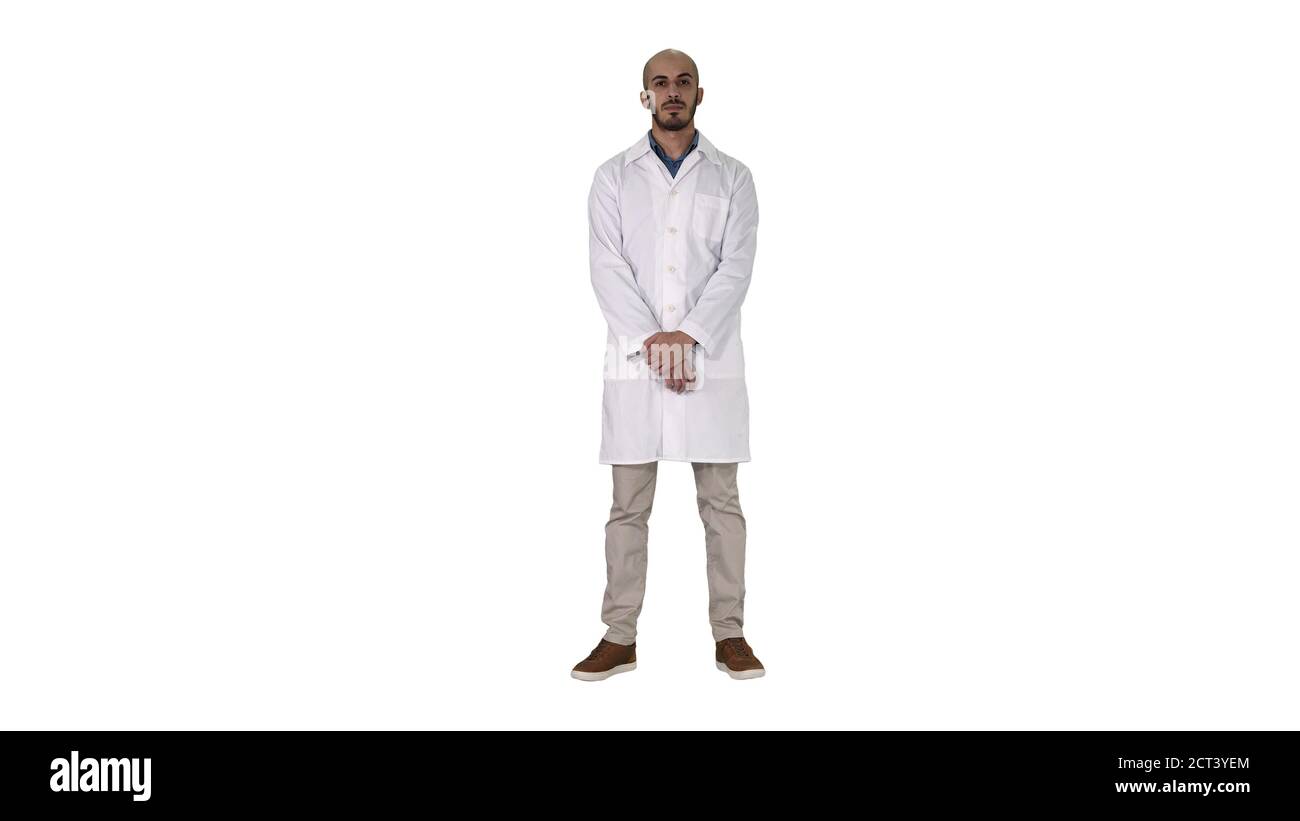 Doctor man is a little bit nervous and scared standing on white ...