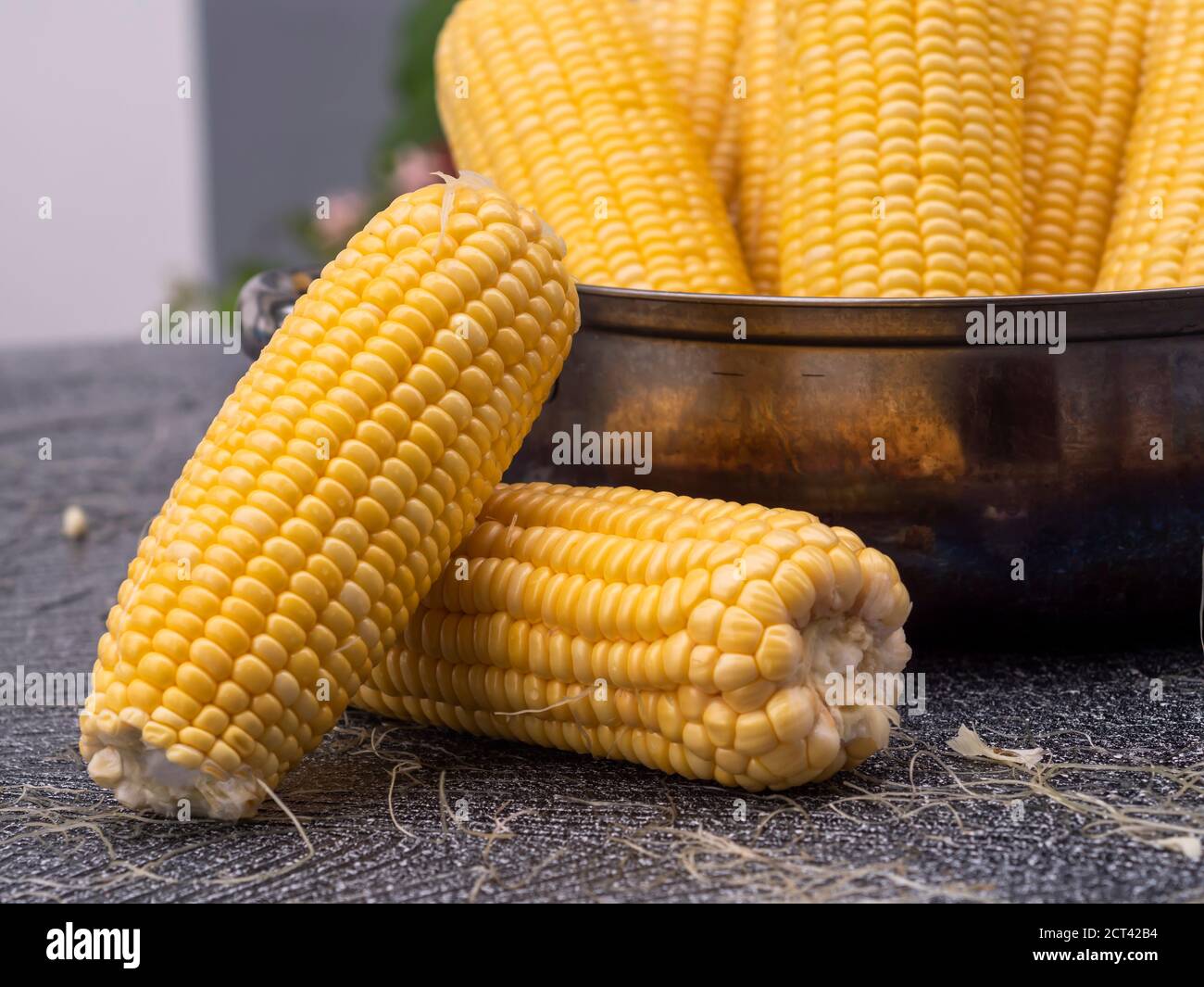 group freshness seeds of sweet corn in a pot on the table. Fresh raw ...