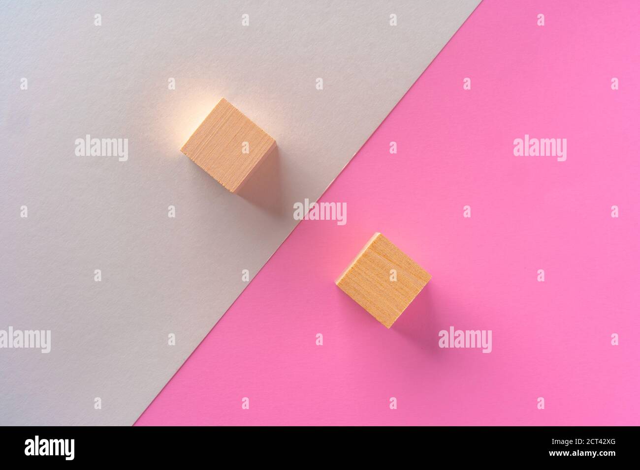 Wooden square block on pink and white background Stock Photo - Alamy