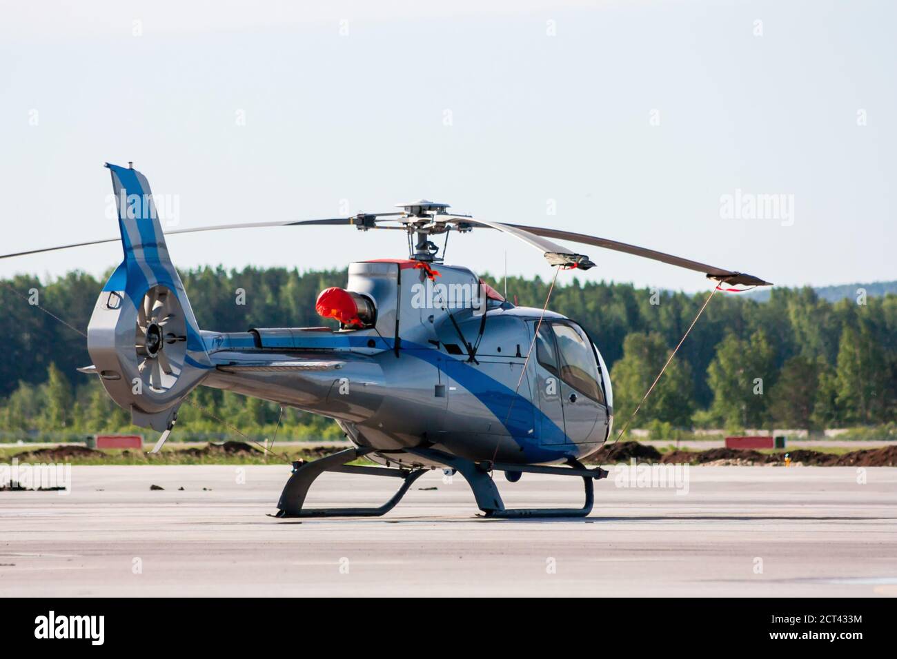 Single engine light helicopter on the airport apron Stock Photo - Alamy