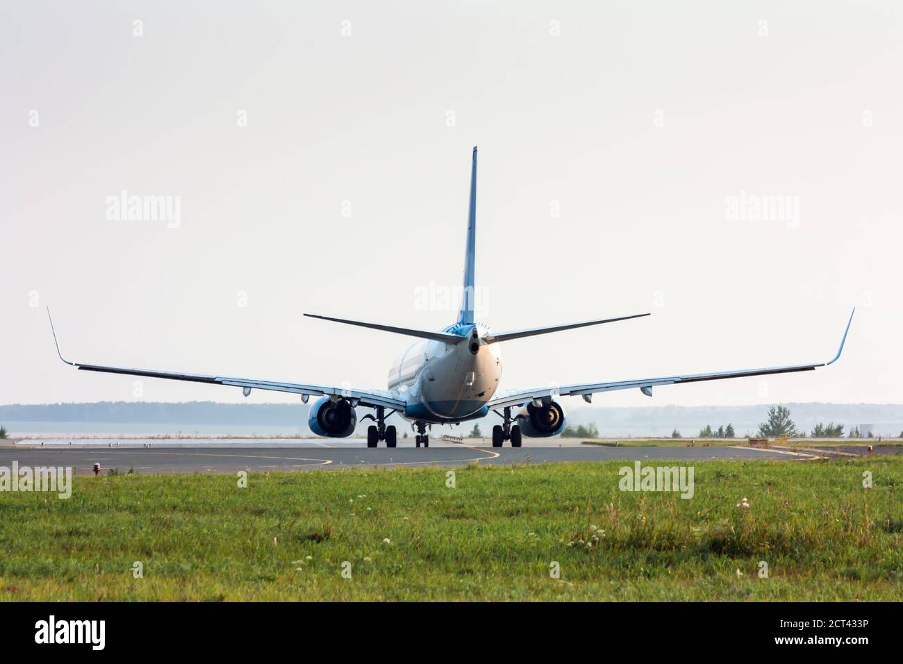Airplane turns on Runway. Back view Stock Photo - Alamy