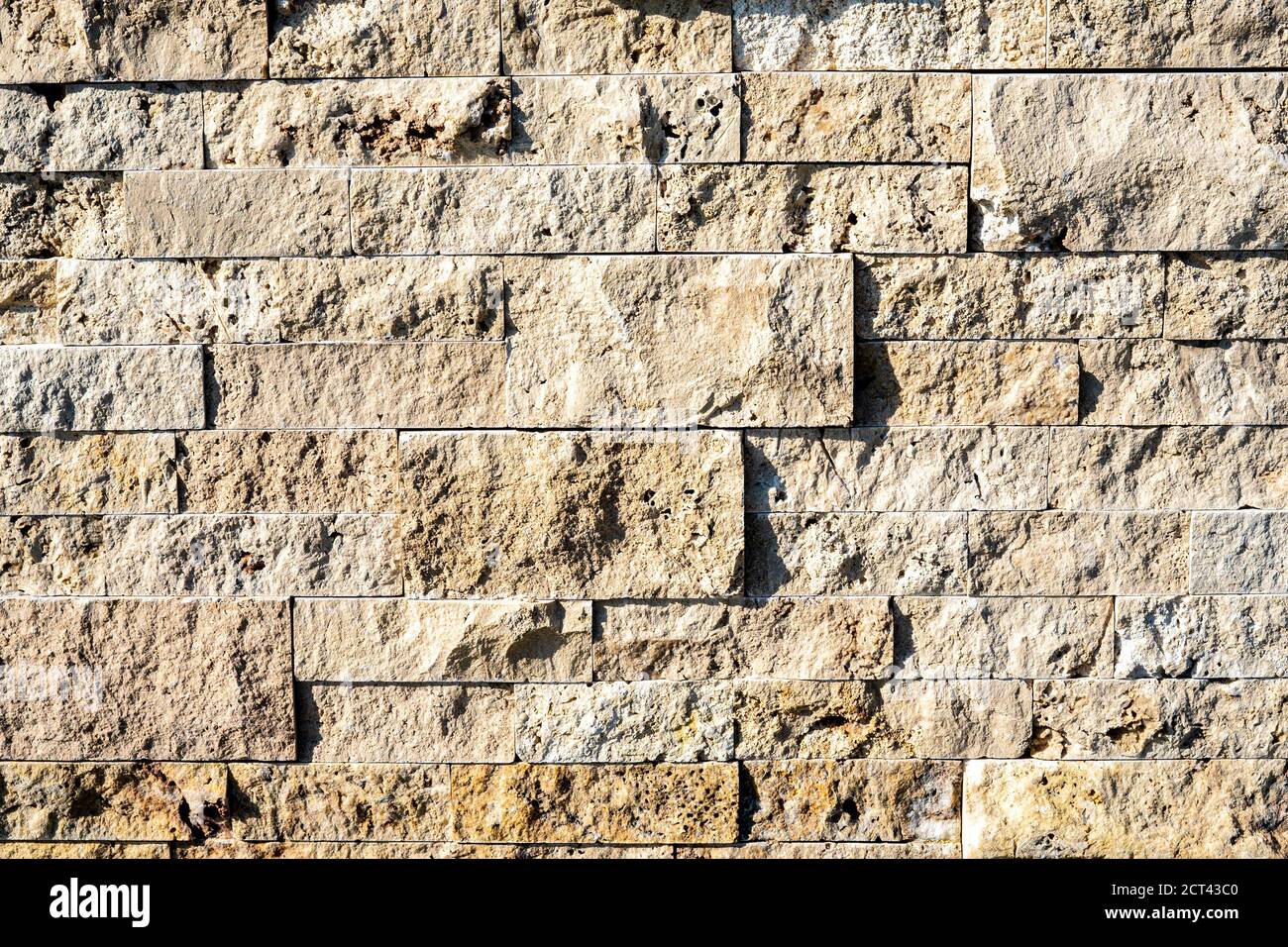 Stone wall brick texture background beige surface facade. Close - up ...