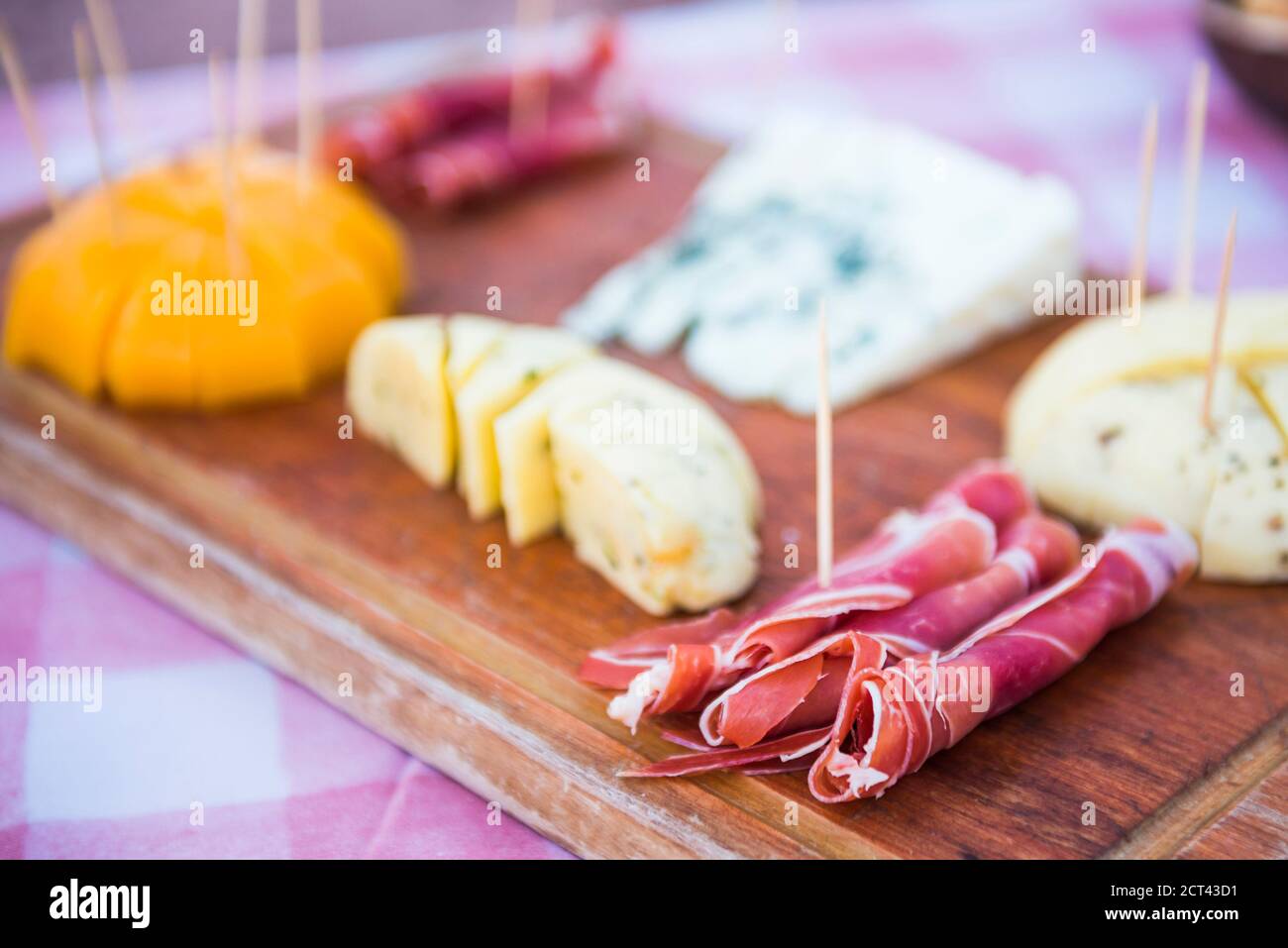 Outdoor platter picnic set up with cheese and dried meats on a chopping ...