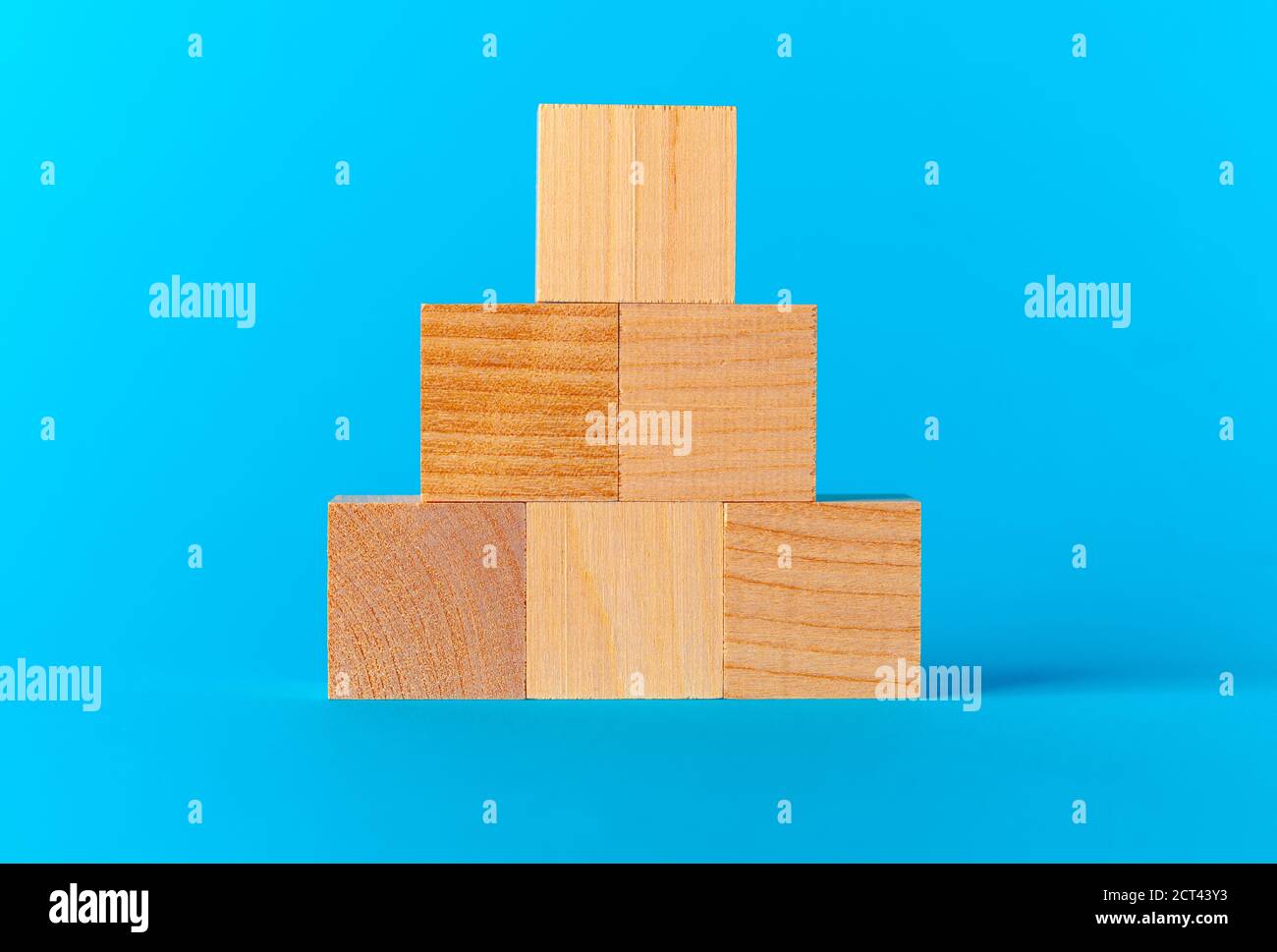 Toy wooden blocks on blue background front view Stock Photo - Alamy