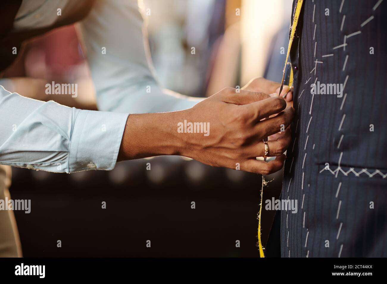 Tailor measuring suit jacket Stock Photo - Alamy