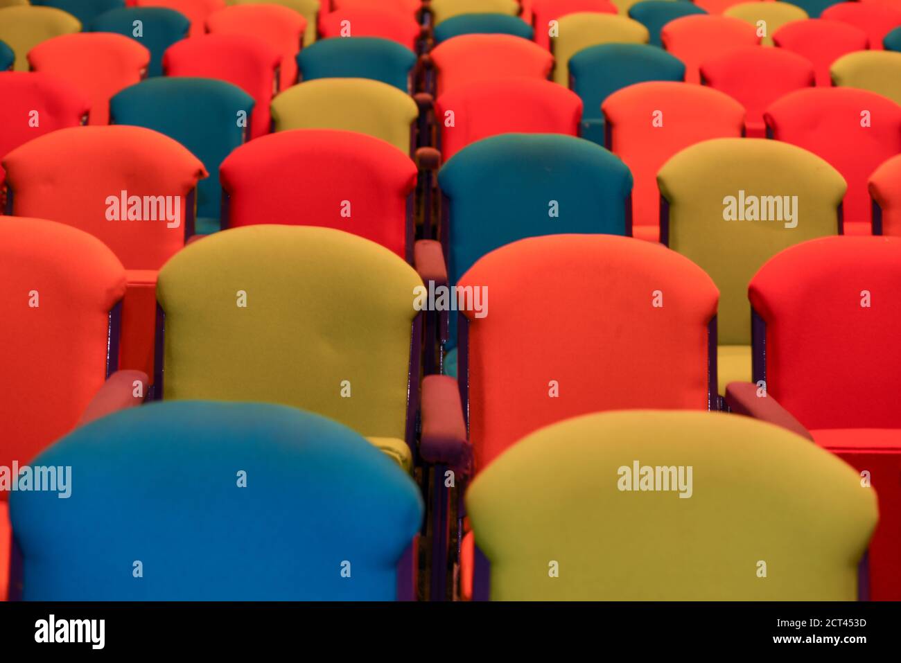 Bright colored chairs in a row forming a pattern Stock Photo - Alamy