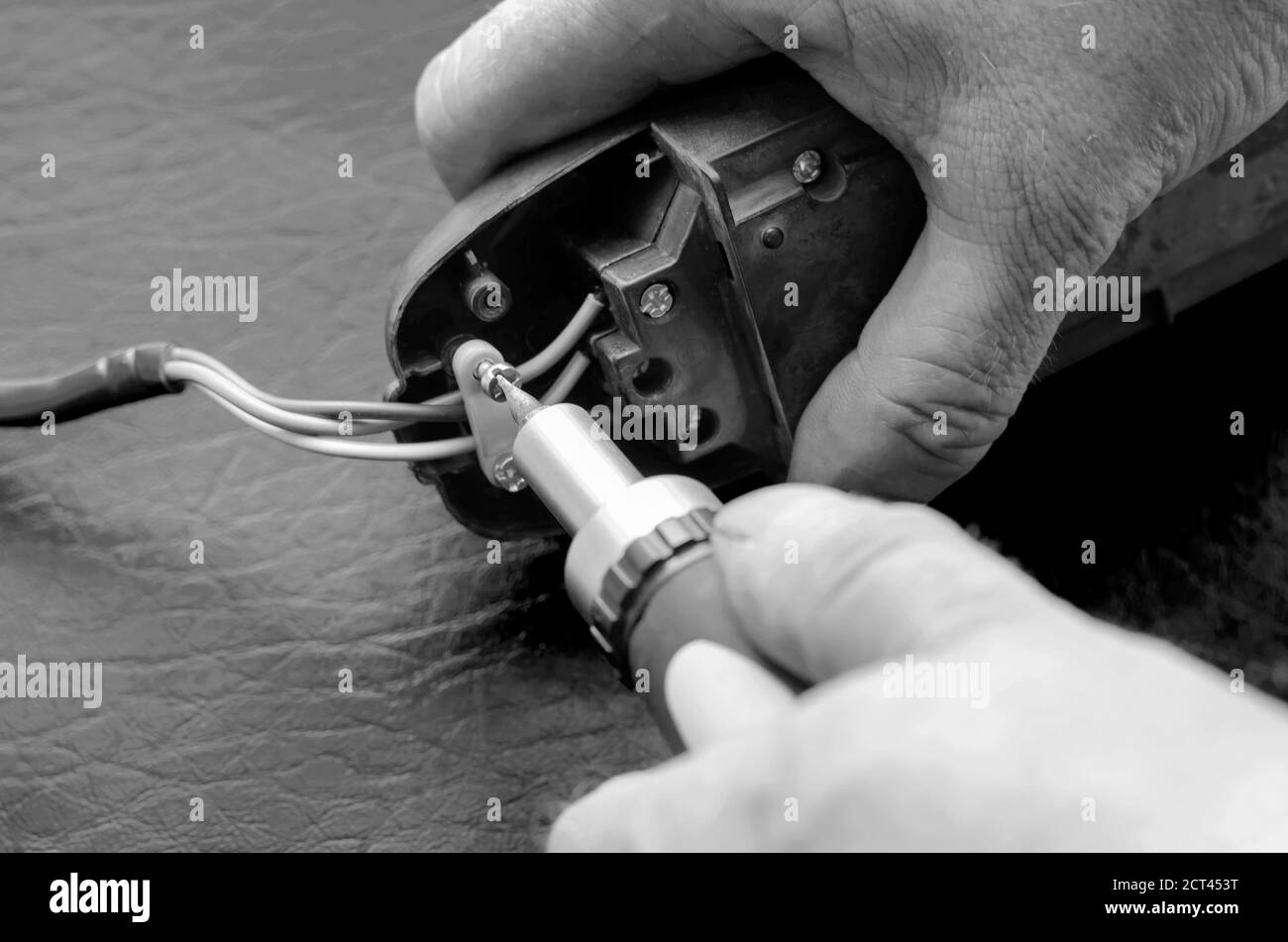 Network splitter and screwdriver in hand. Male hands are repairing an ...