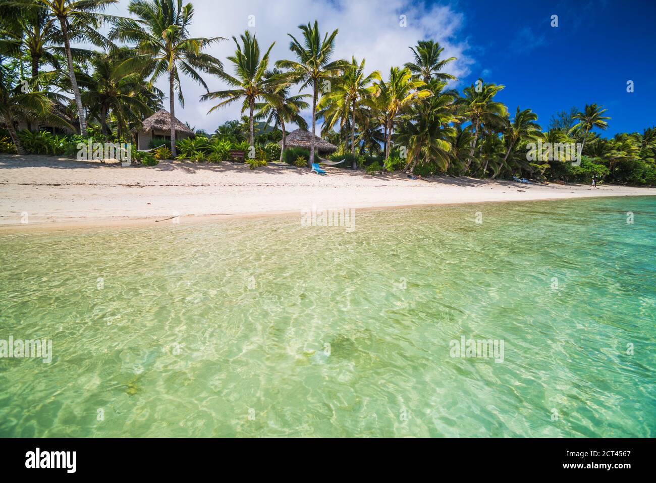Crystal clear Pacific Ocean water and tropical white sandy beach with ...