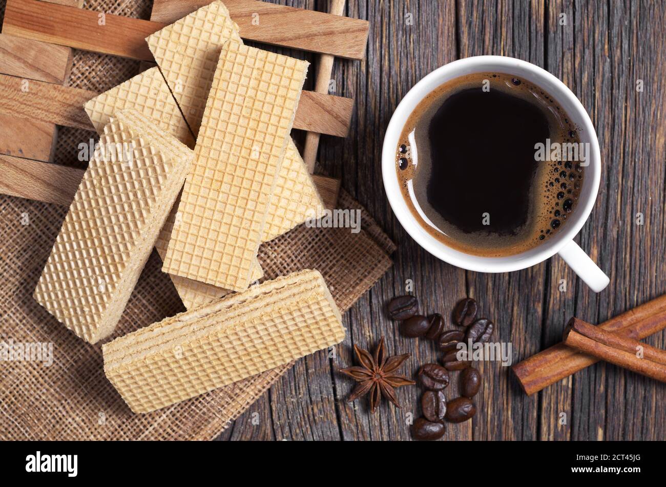 Delicious wafers and cup of hot coffee for breakfast on rustic wooden ...