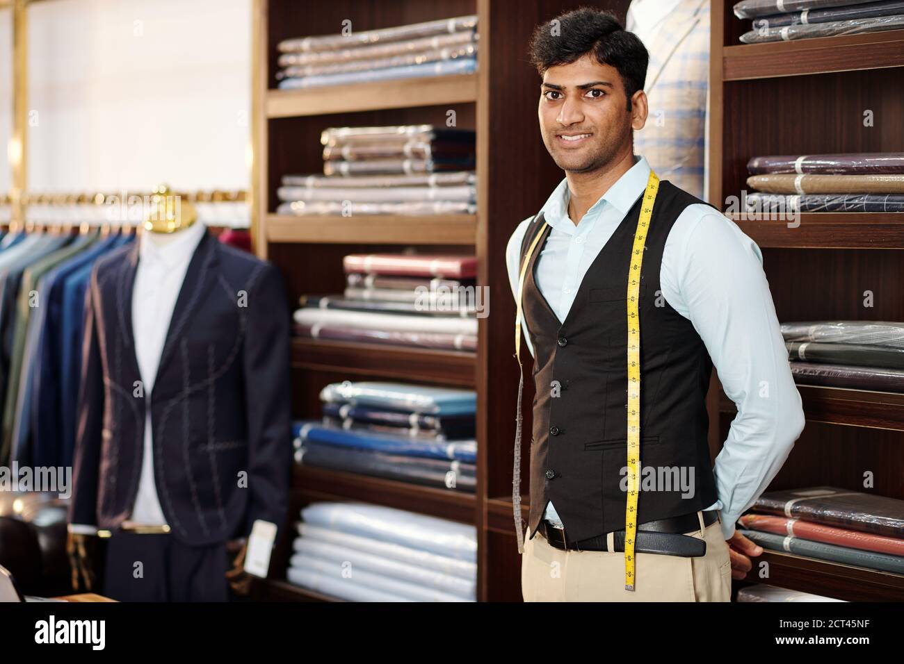 Smiling confident Indian tailor Stock Photo - Alamy