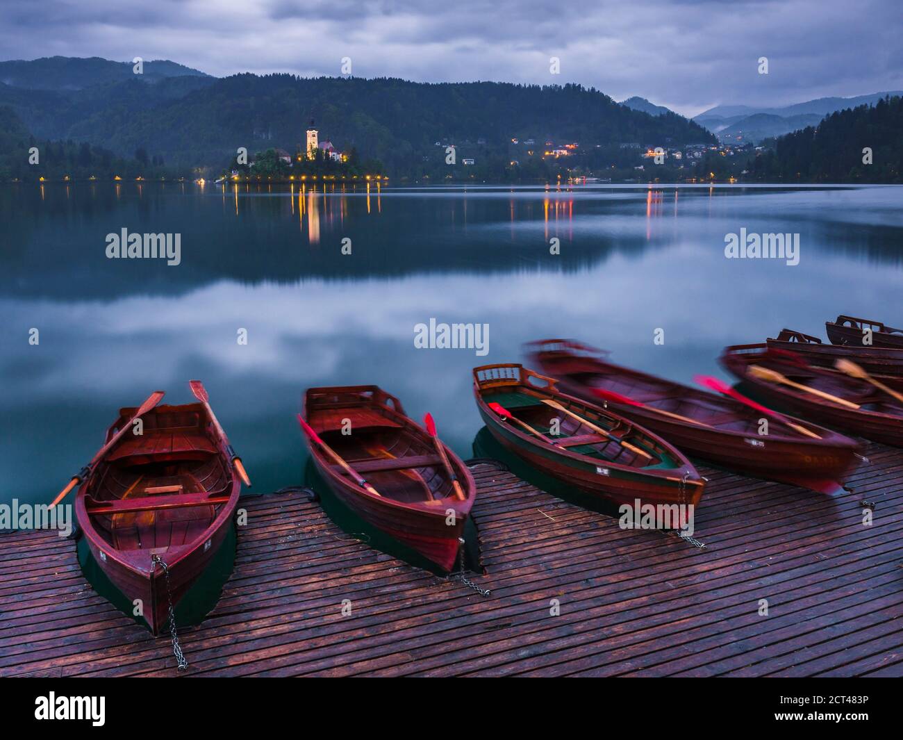 Pletna rowing boats and Lake Bled Island at twilight, Bled, Gorenjska ...