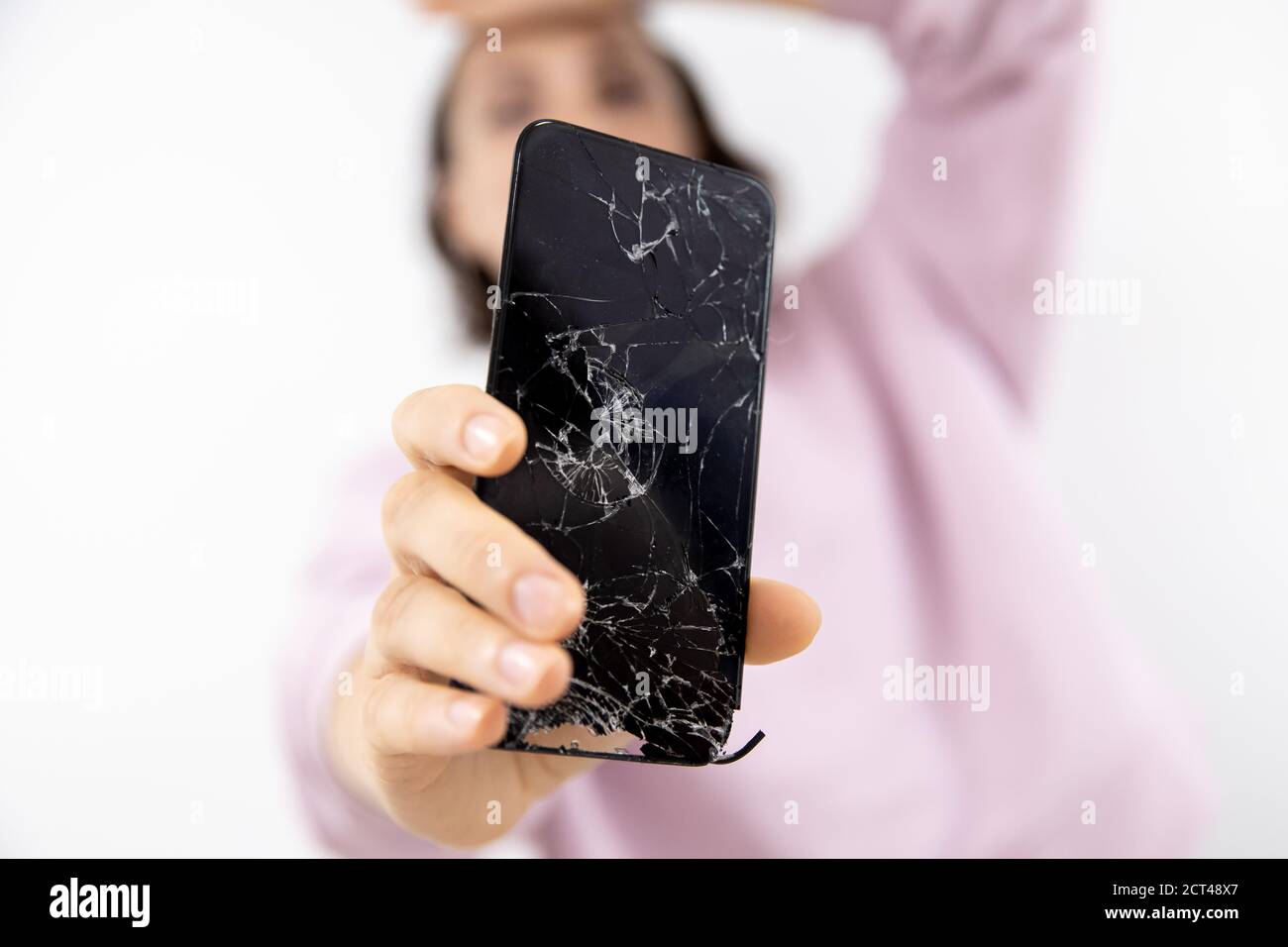 Broken glass screen of phone in hands of woman, white background Stock ...