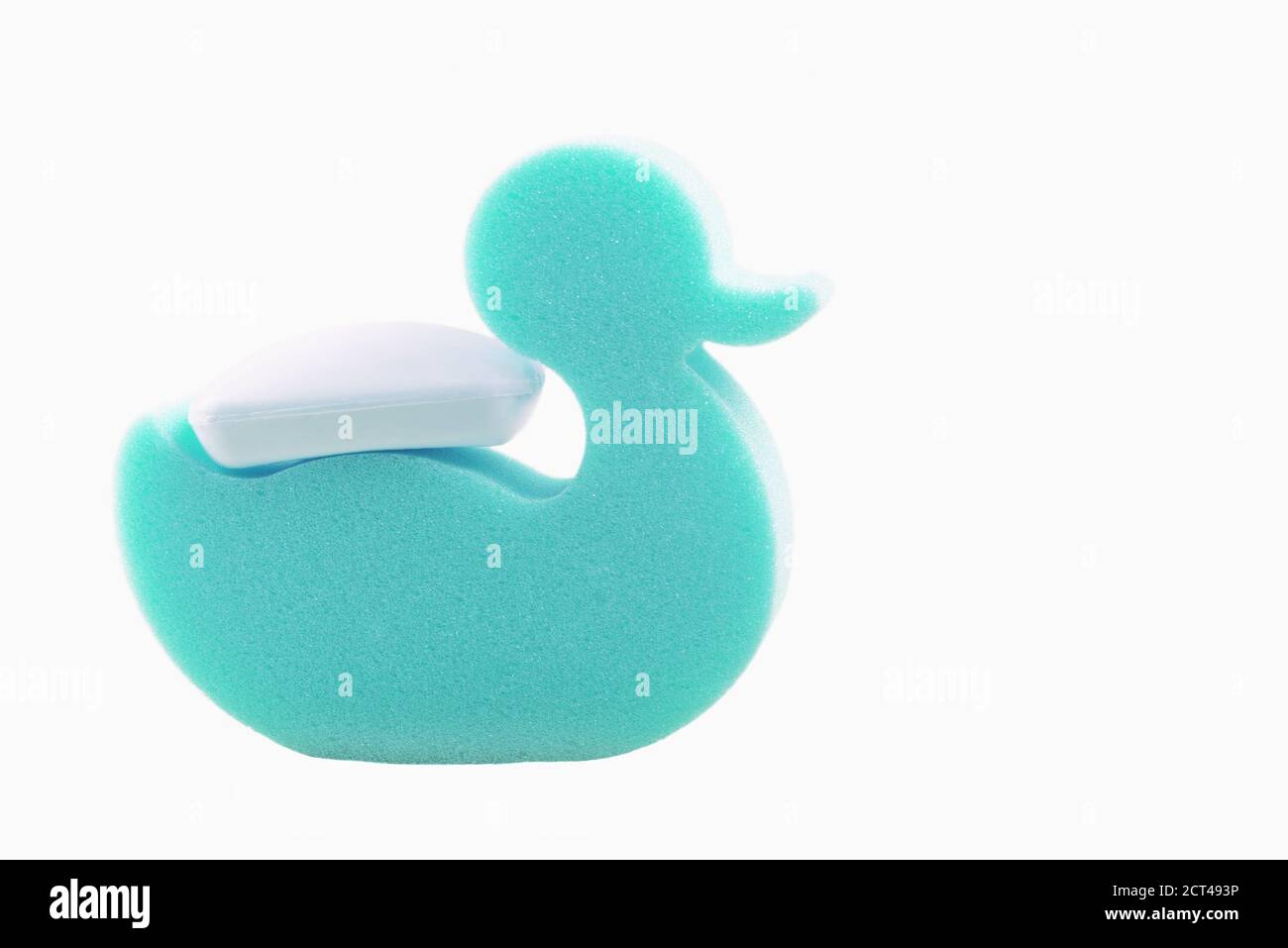 Cyan duck sponge carrying piece of soap on its back against white ...