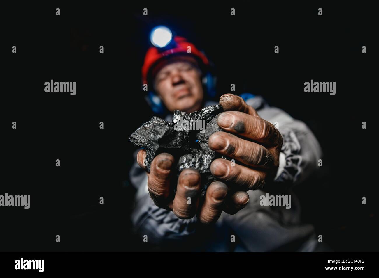 Miner man worker holds coal palm. Concept mining Stock Photo - Alamy Miner man worker holds coal palm. Concept mining Stock Photo - Alamy