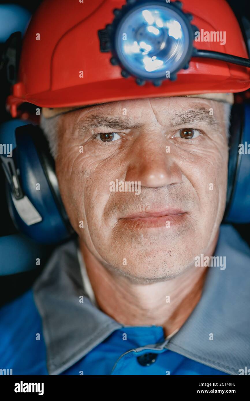 Portrait miner coal man in helmet with lantern in underground mine ...