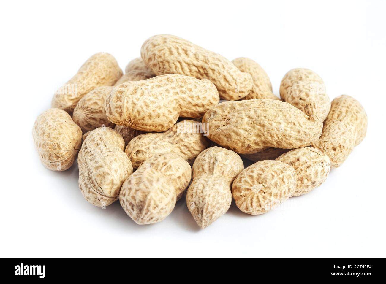 Bunch of whole roasted peanut shells on white background Stock Photo ...