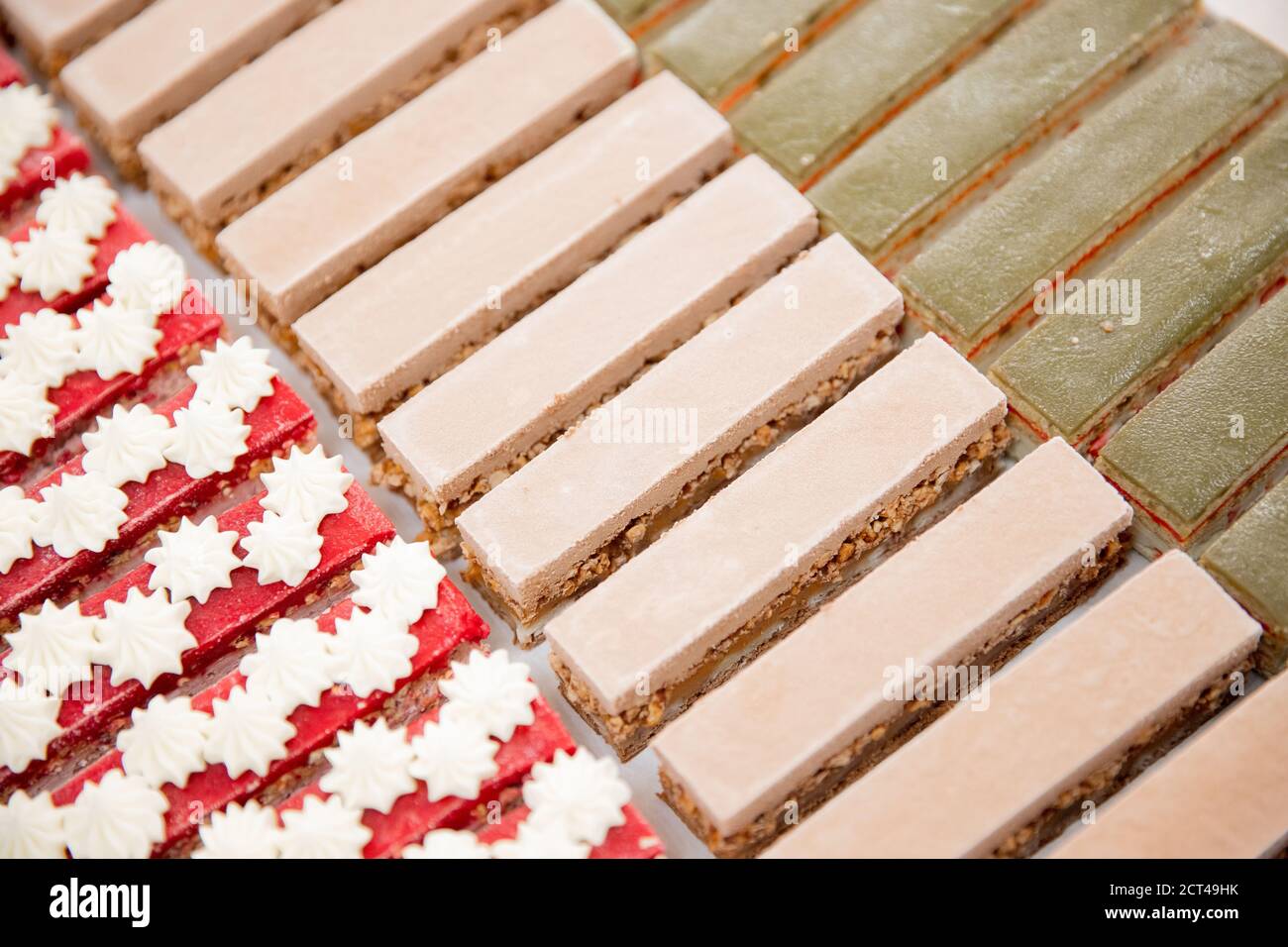 Close-ups of row cake buttercream brownies on display catering sweet ...