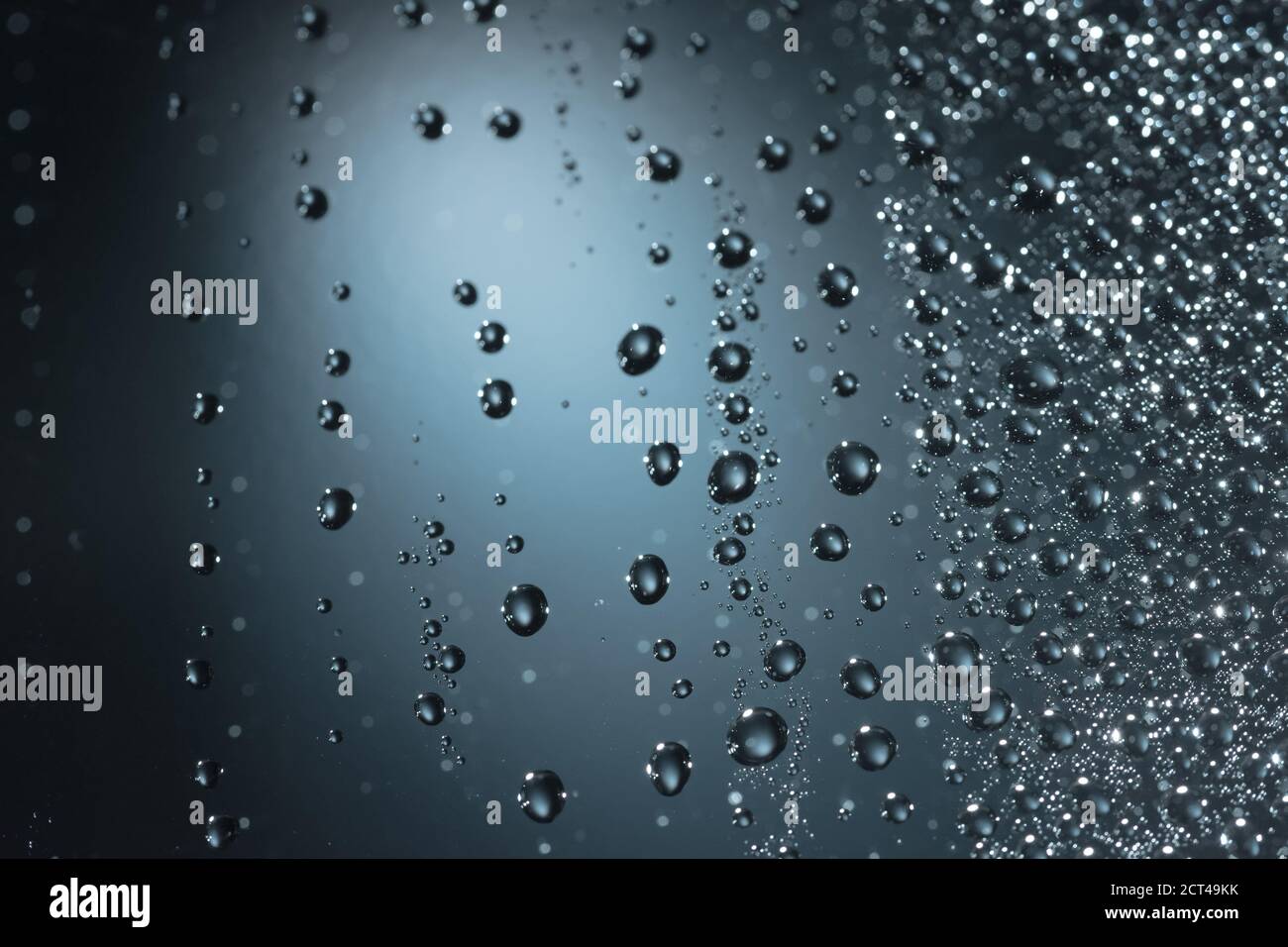 Water drops and water mist hang picturesquely on a glass shelf with ...