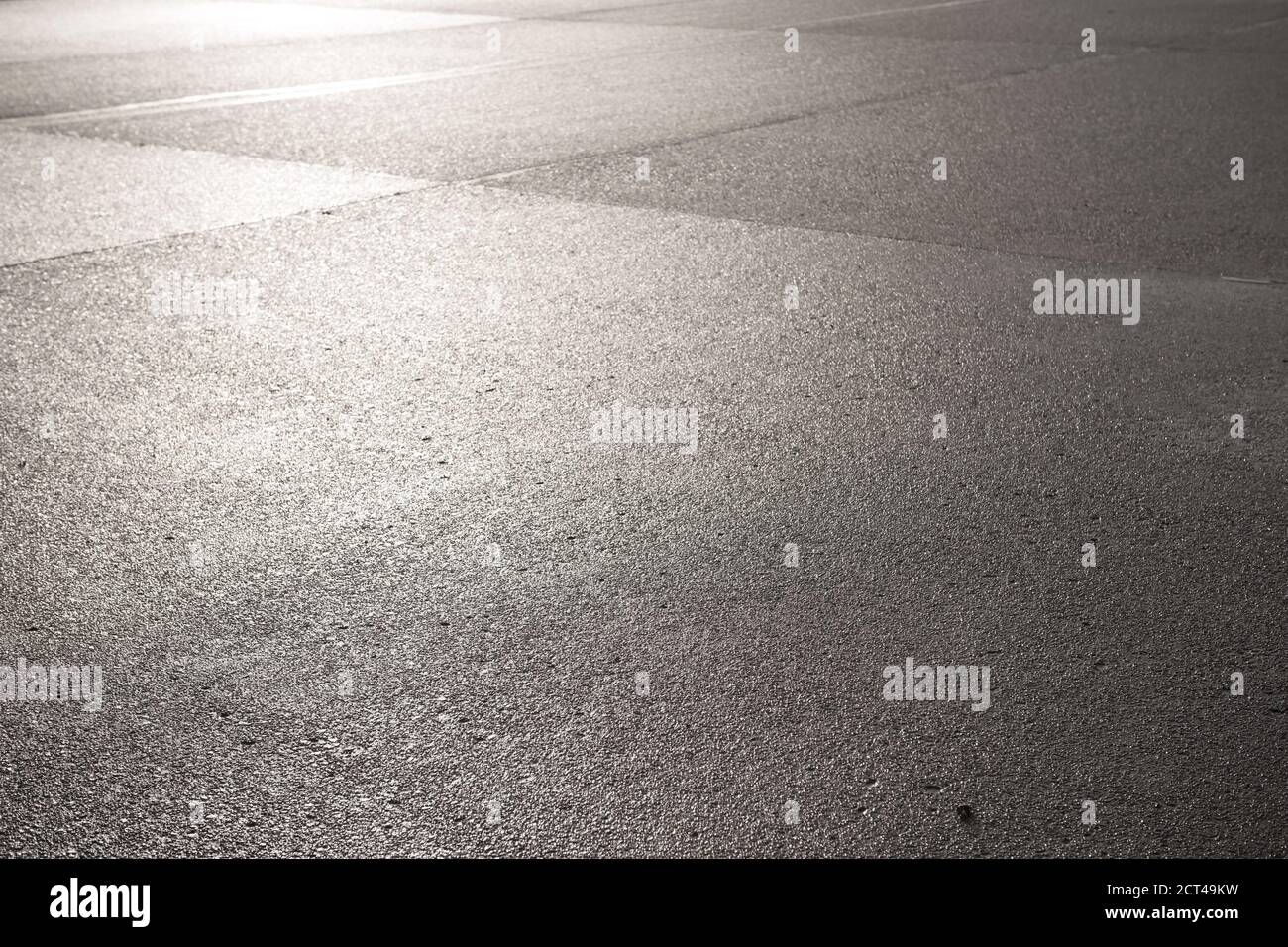 The shiny damp surface of a concrete square appears in large squares in ...