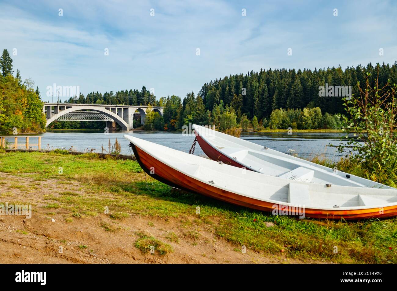 Autumn landscape of bridge and boats on Kymijoki river in Finland ...