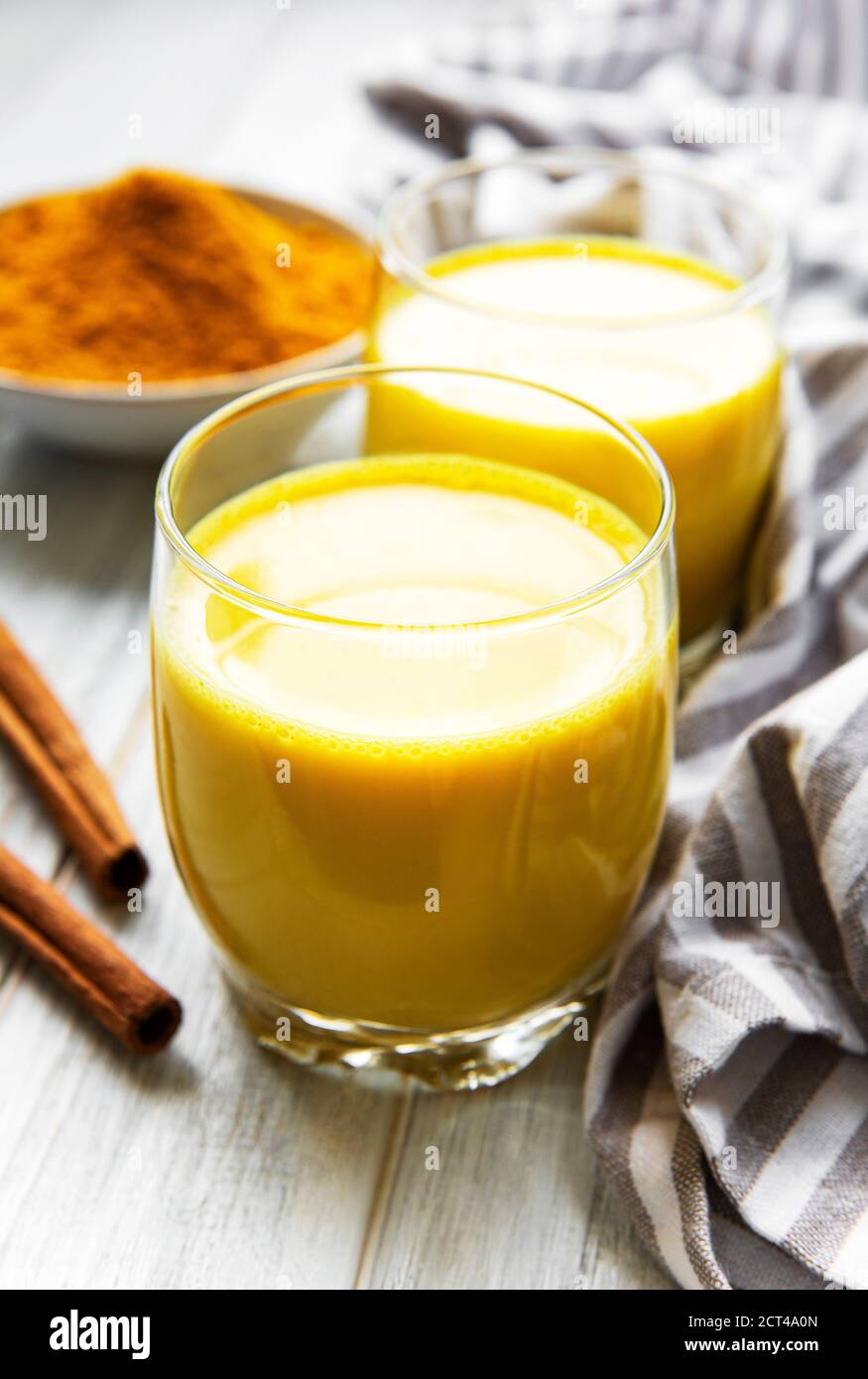 Yellow turmeric latte drink. Golden milk with cinnamon, turmeric ...
