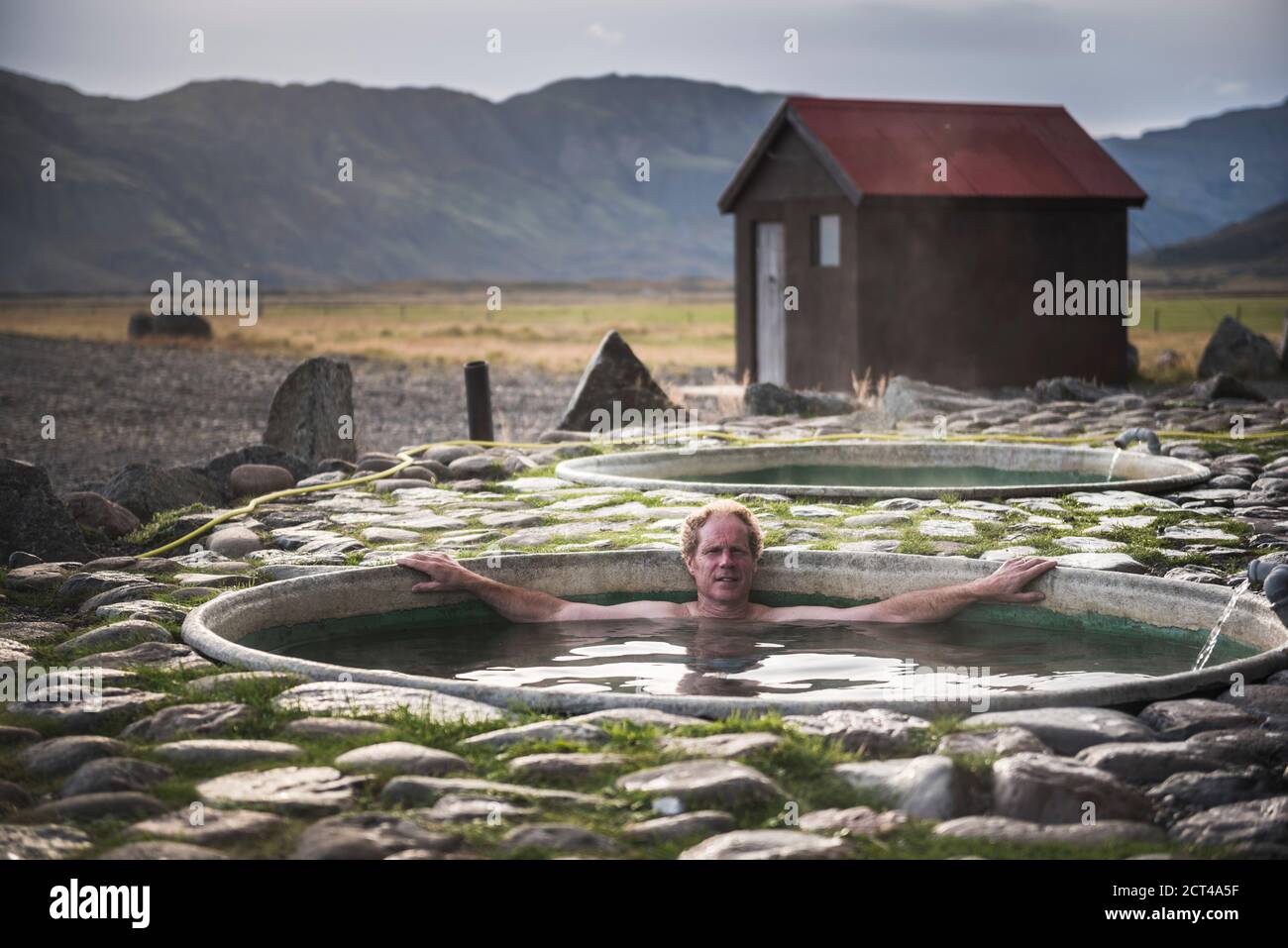 Tourist bathing at Hoffell Hot Tubs near Hofn, South east Iceland ...