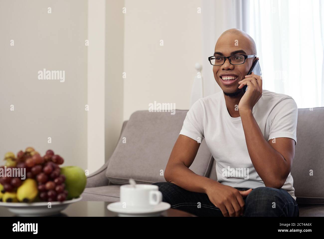Happy man talking on phone Stock Photo - Alamy