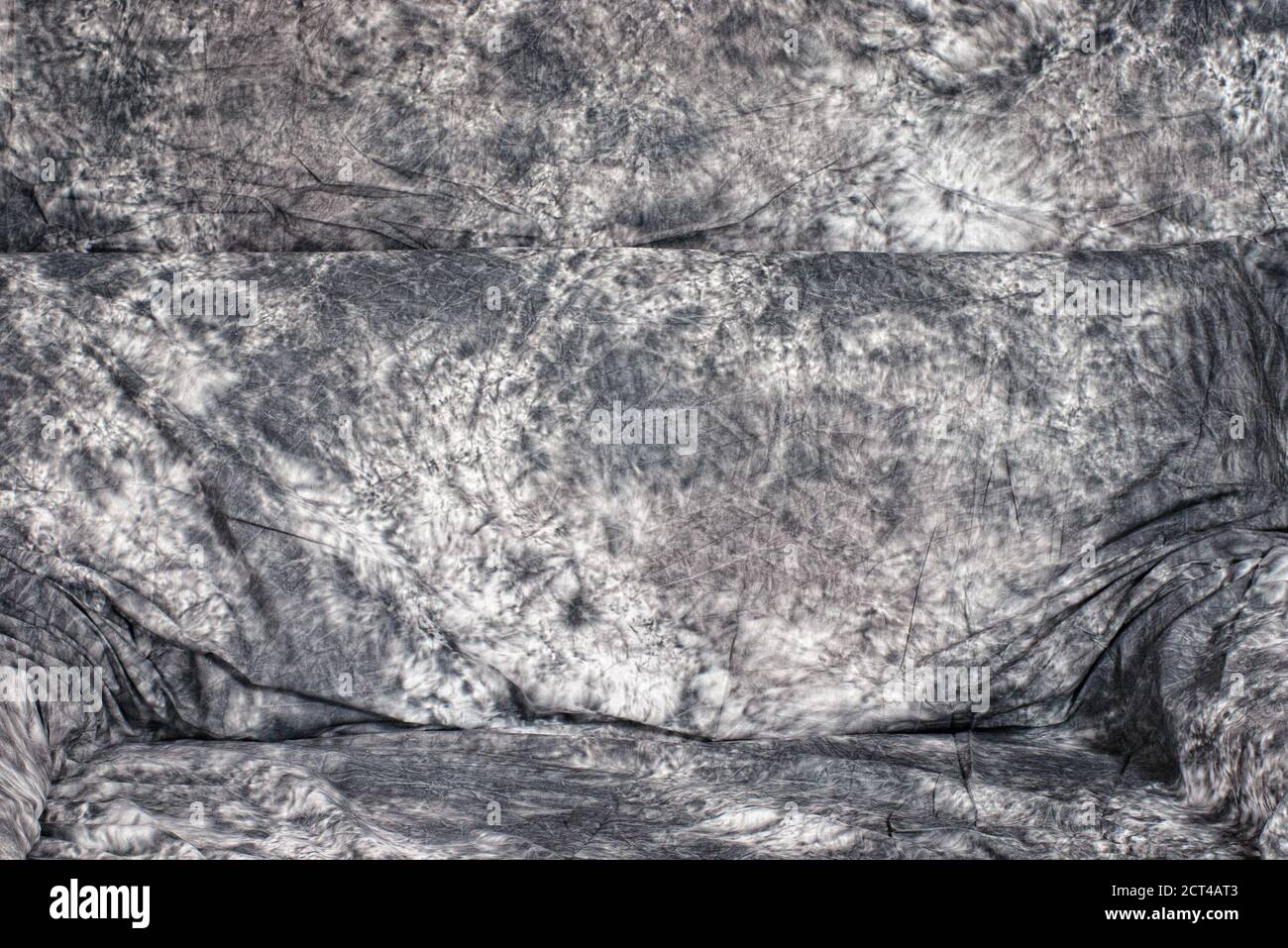Grey photography muslin photo backdrop covering couch Stock Photo - Alamy