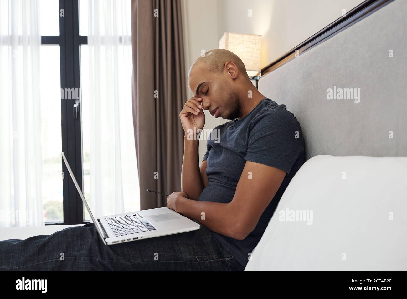 Programmer tired of coding Stock Photo - Alamy