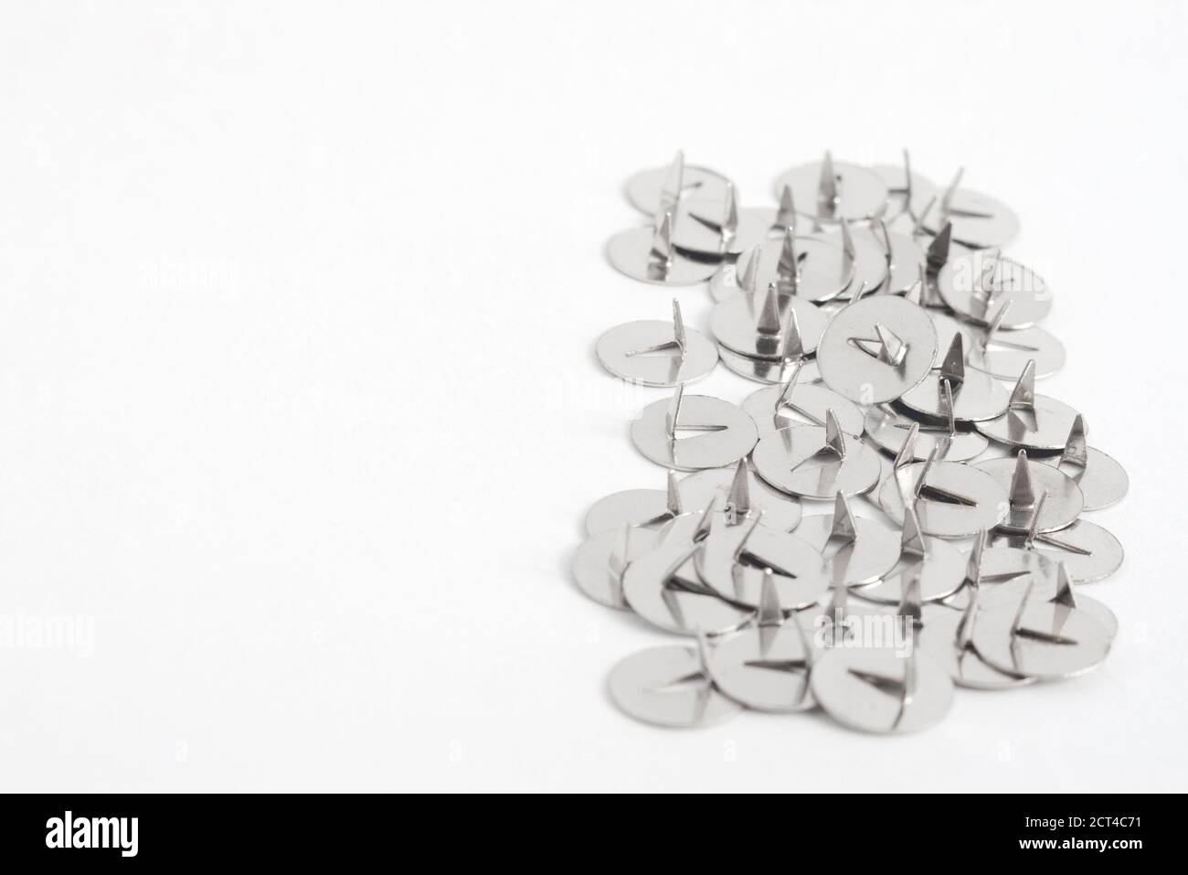 Bunch of old-fashioned metal drawing pins turned upside down with copy ...