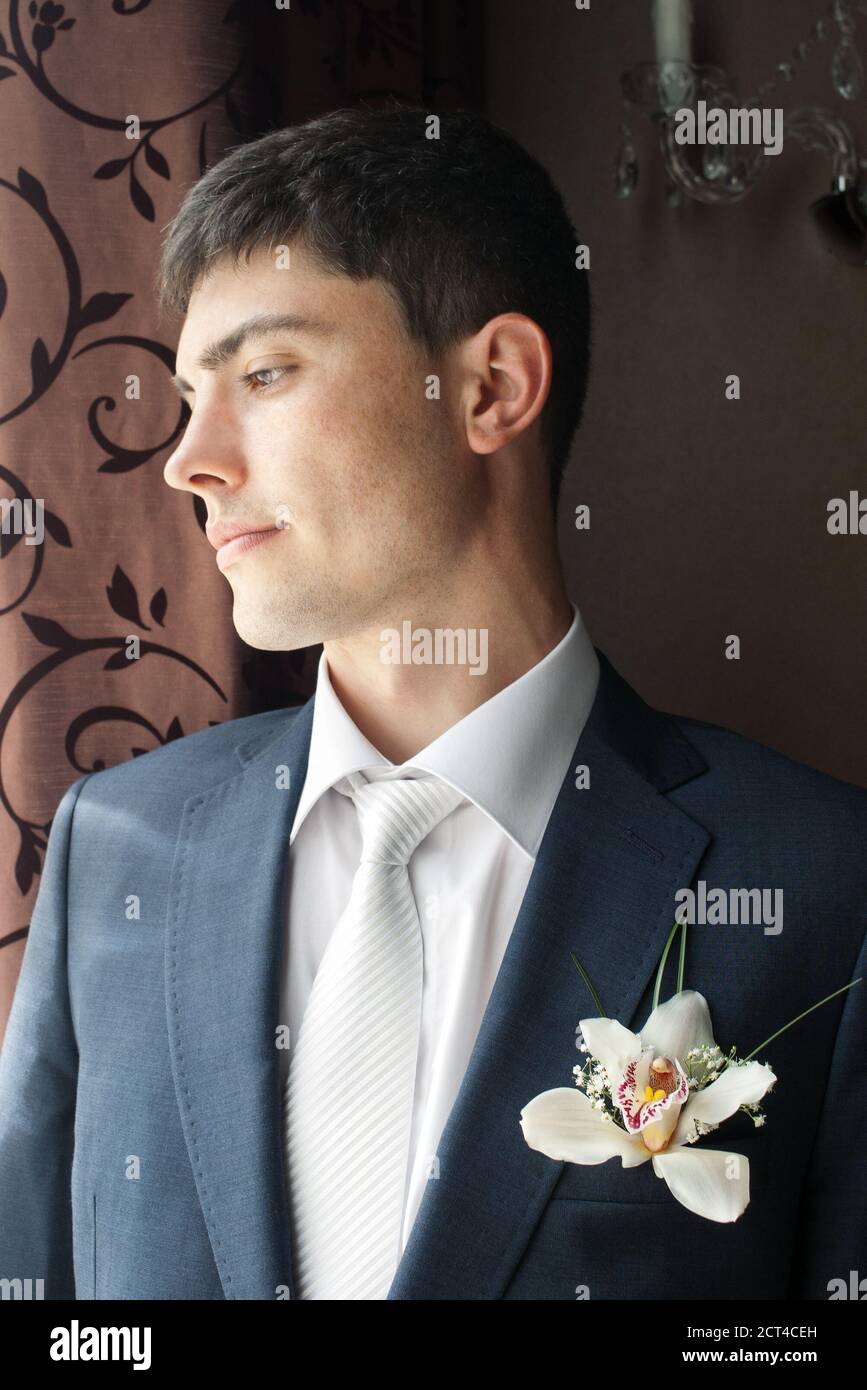 Handsome groom with orchid flower in buttonhole with face forward Stock ...