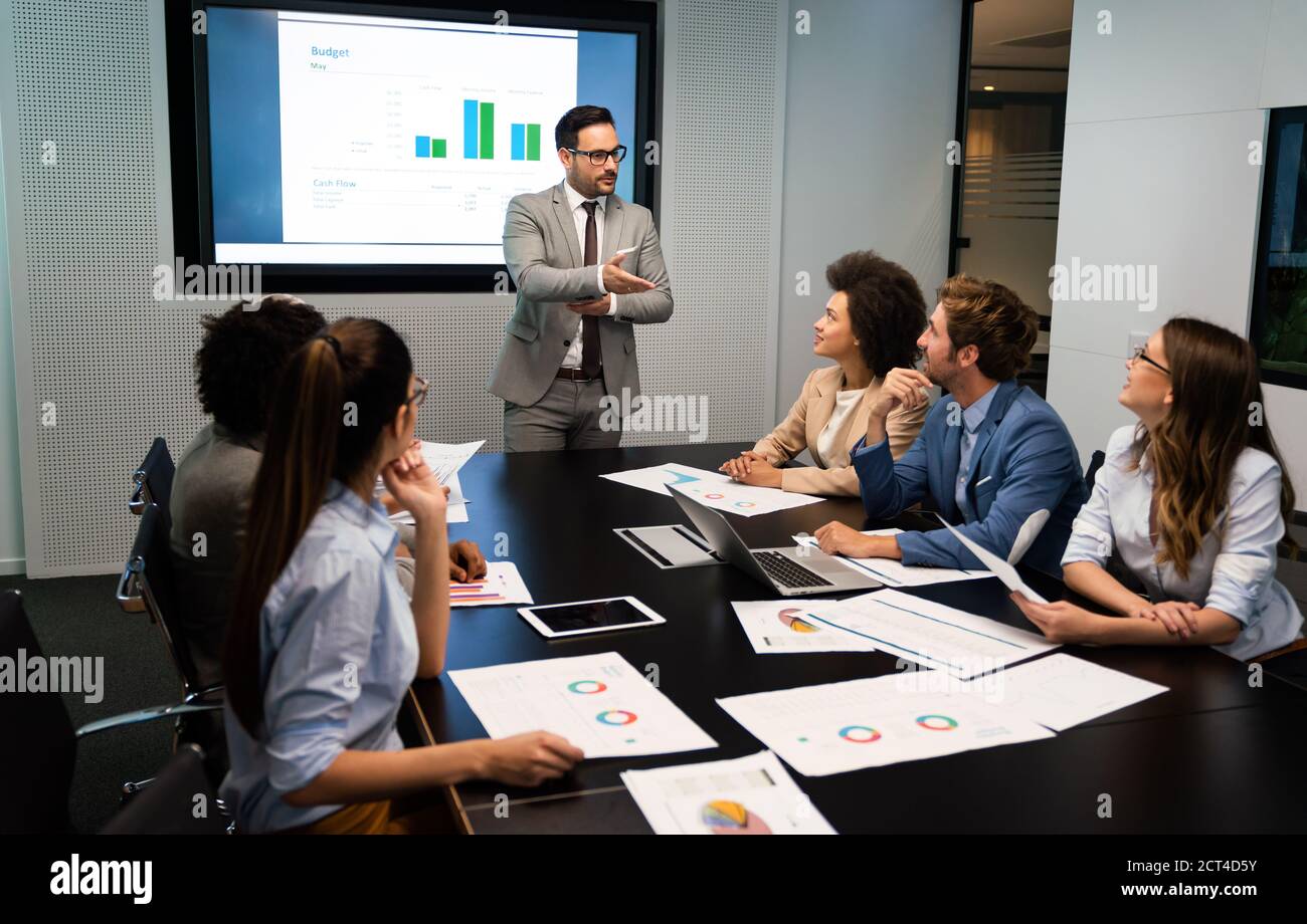 Happy diverse business colleagues meeting, working in modern office ...