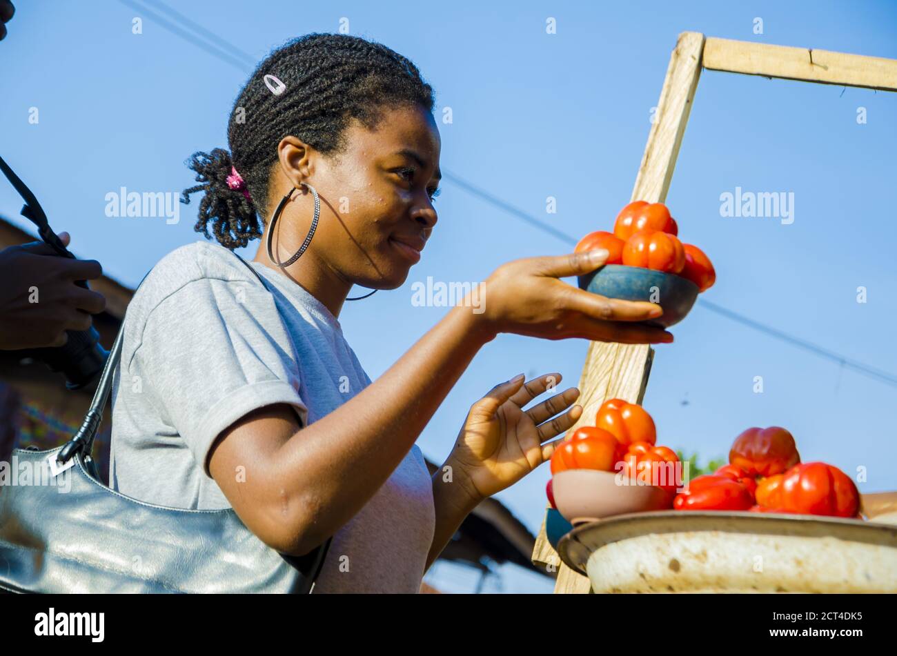 Pretty Afro-American female buying vegetables in the market Stock Photo ...