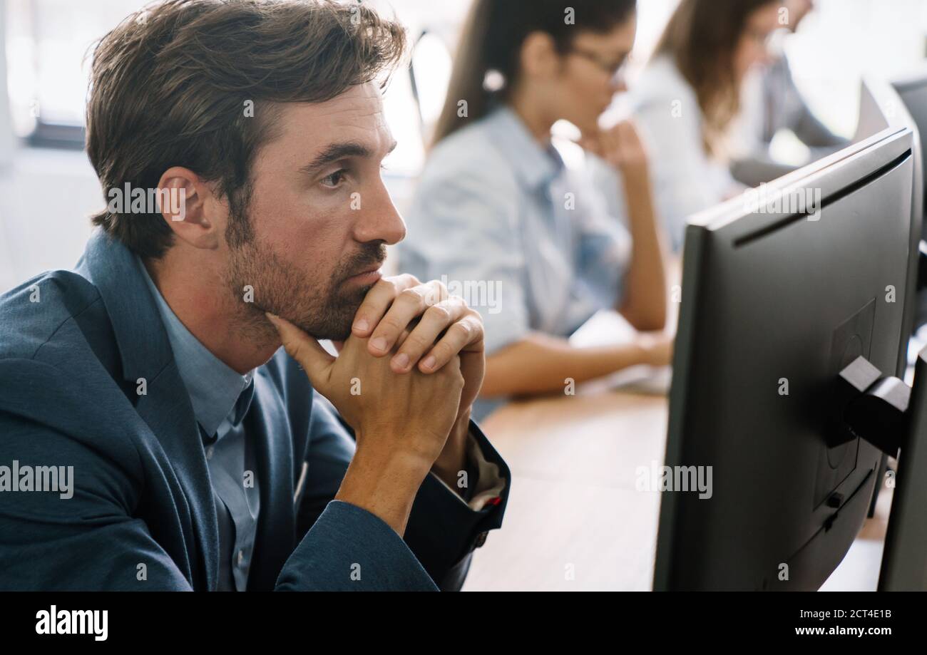 Programmers cooperating at IT company developing apps Stock Photo - Alamy
