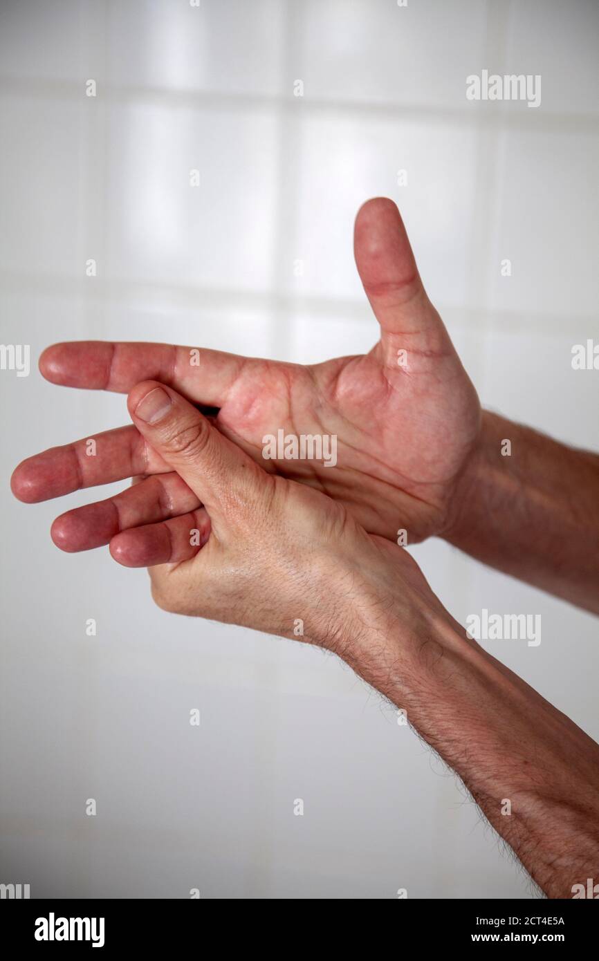 Man Rubbing Hands with Sanitizer Stock Photo - Alamy