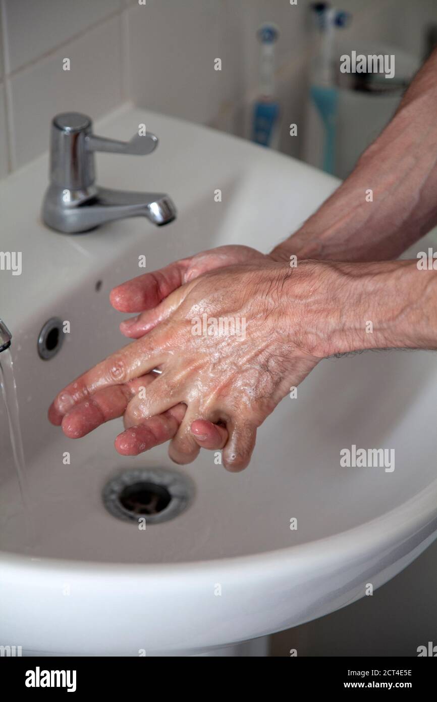 Man Washing Hands over Basin Stock Photo - Alamy