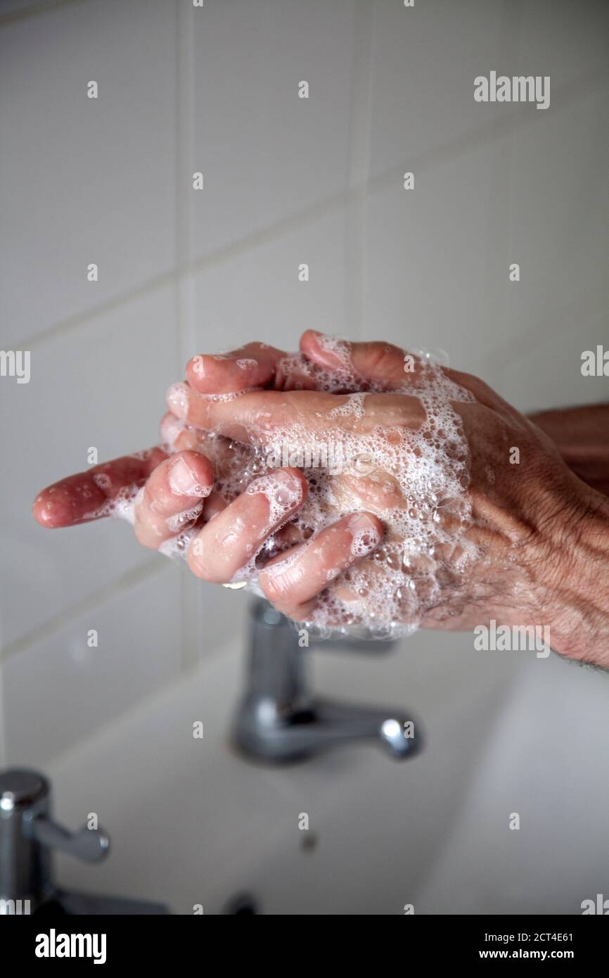 Man Washing Hands over Basin Stock Photo - Alamy
