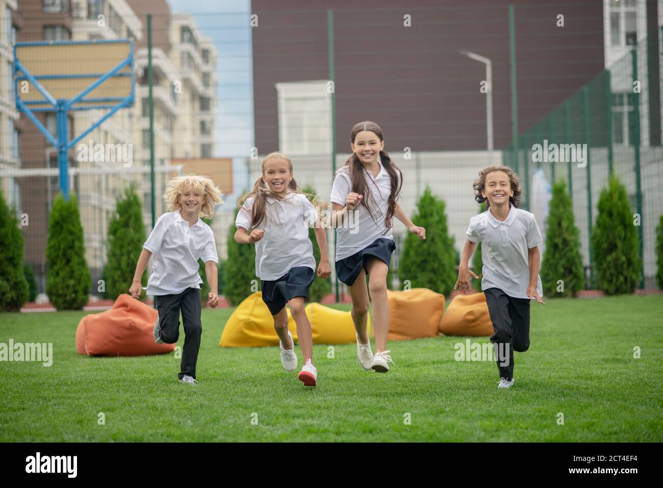 Group of children running and looking excited Stock Photo - Alamy