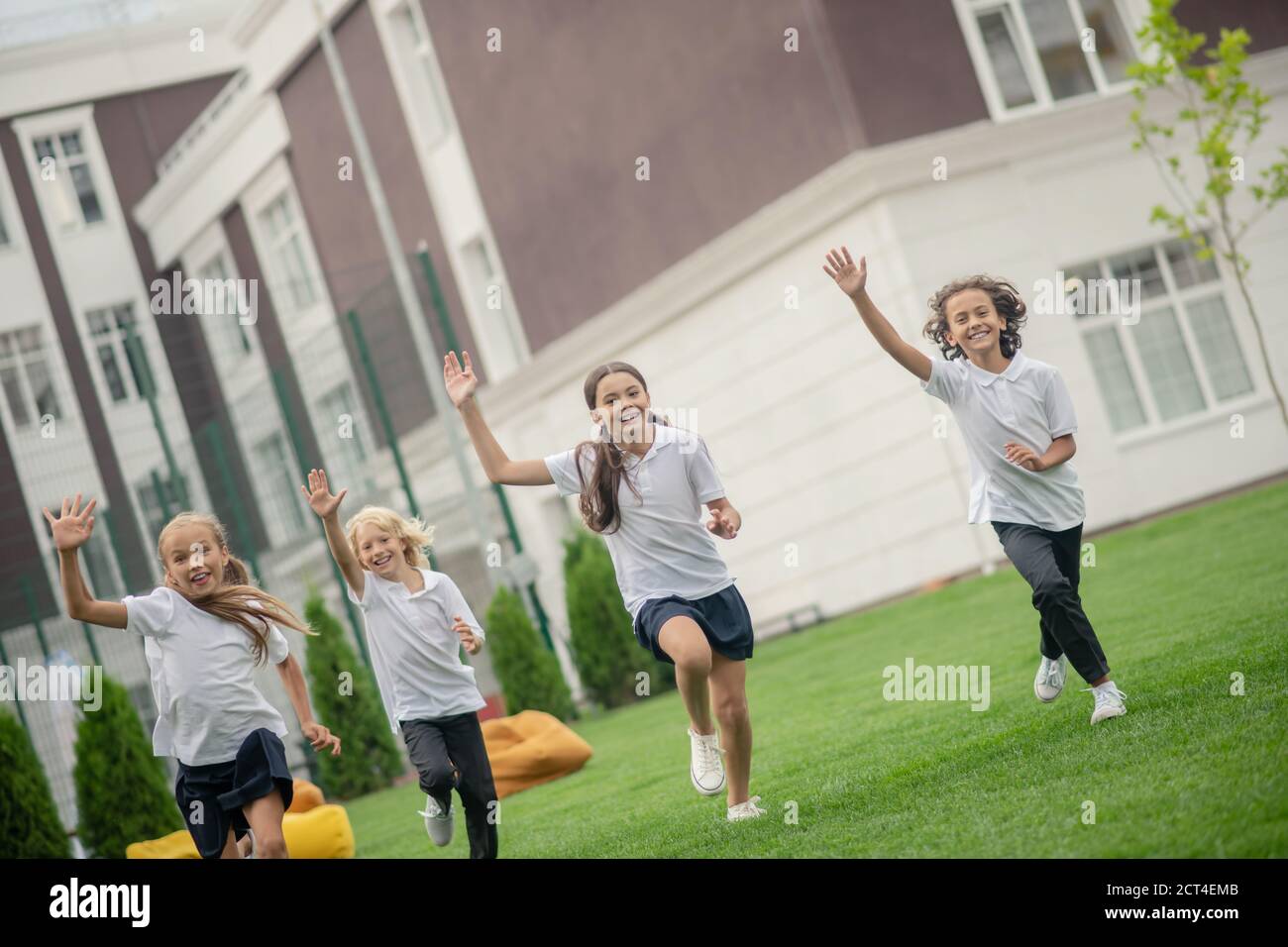 Group of teens having a running competition and waving hands Stock ...