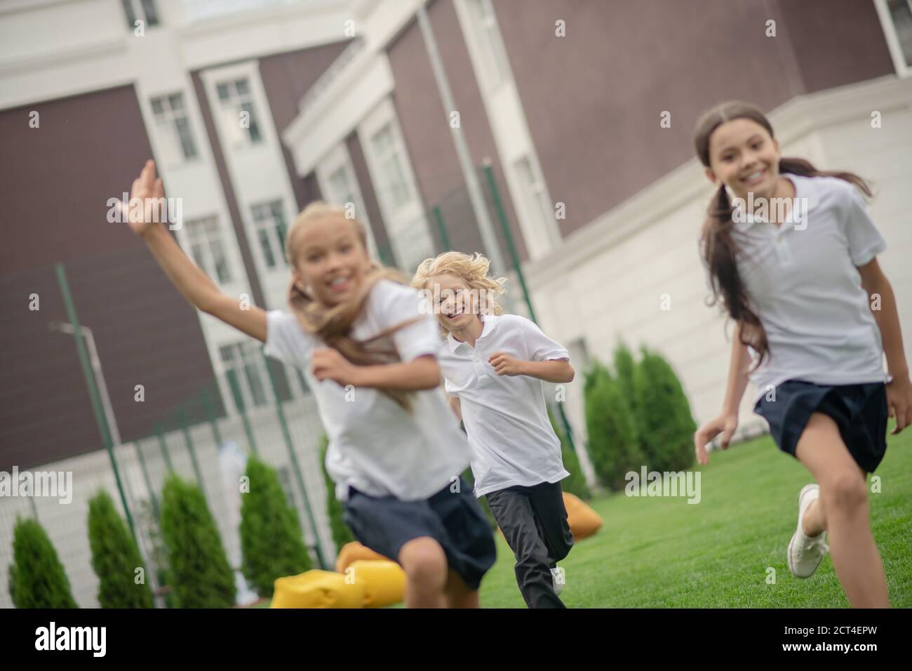 Group of teens having a running competition and looking excited Stock ...