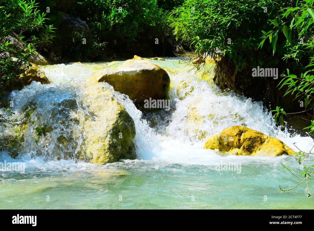 Water falling on beautiful stones and splashes on lake Stock Photo - Alamy