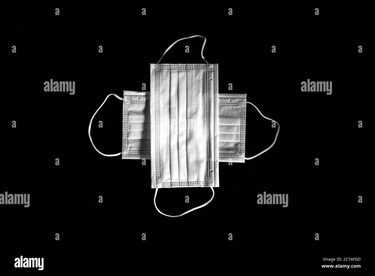 Two safety mask in shape of a cross on black background for Covid-19 ...