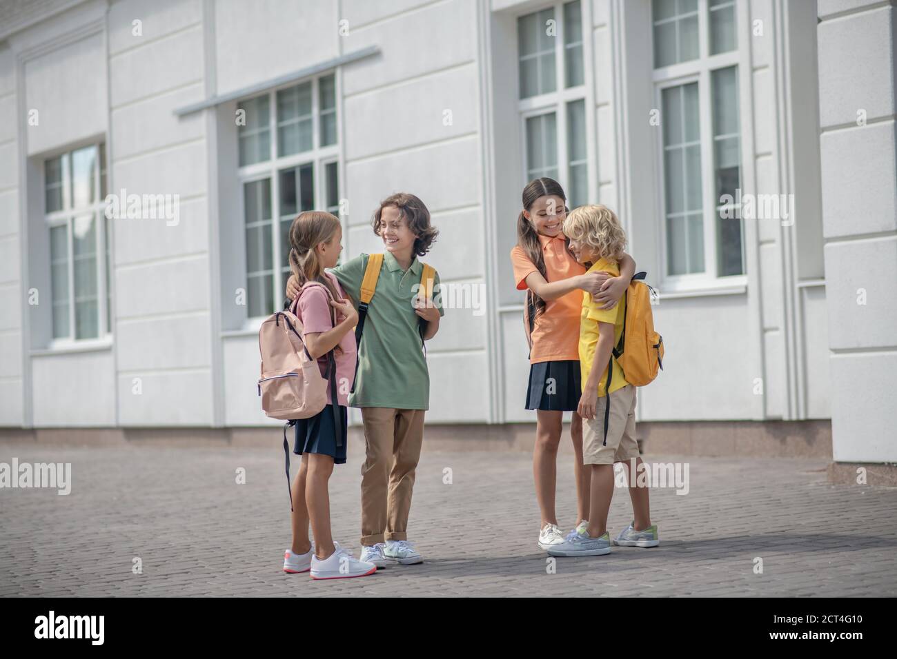 Kids hugging school hi-res stock photography and images - Alamy