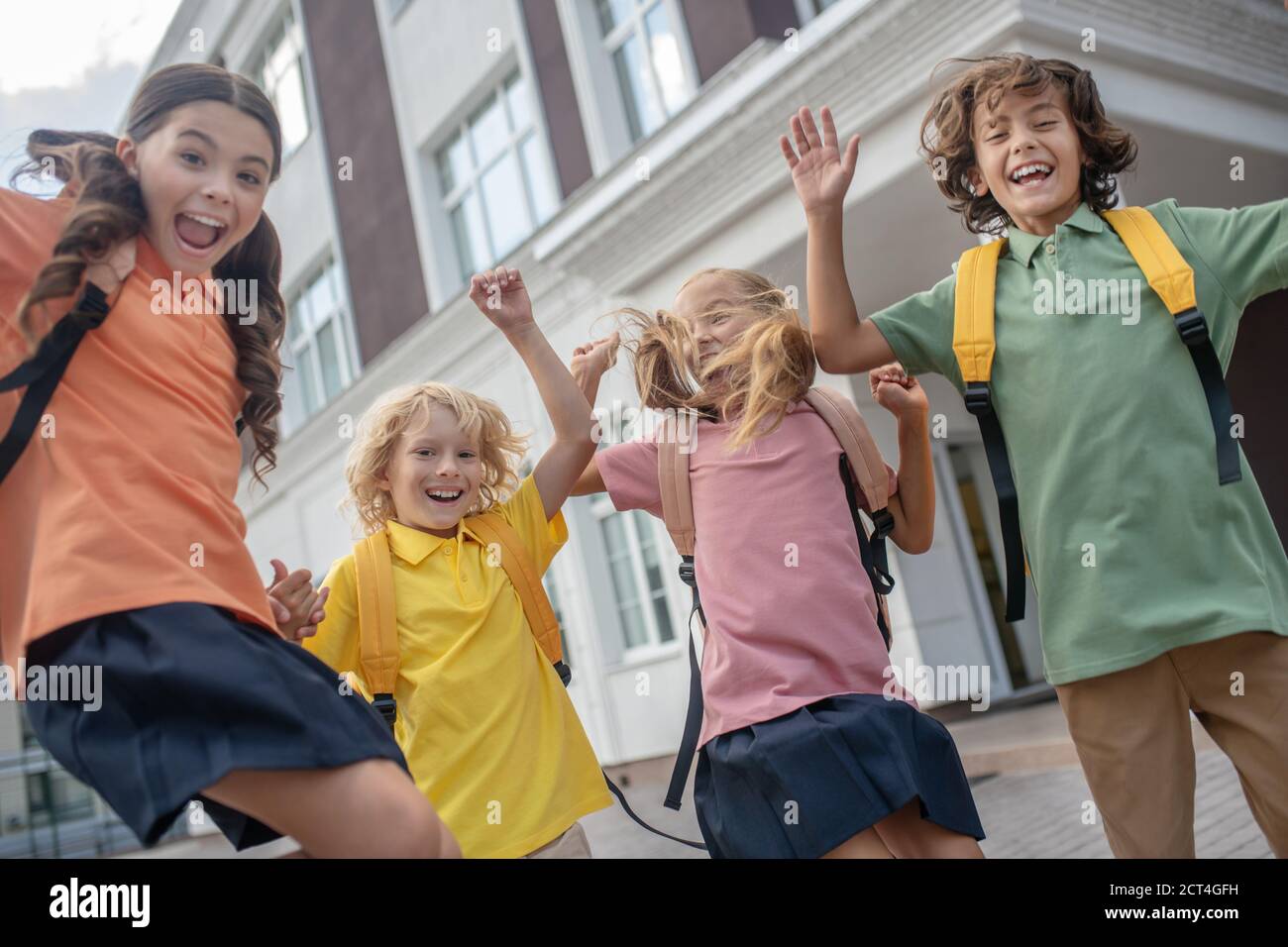 Schoolchildren playing in school yard and looking excited Stock Photo ...